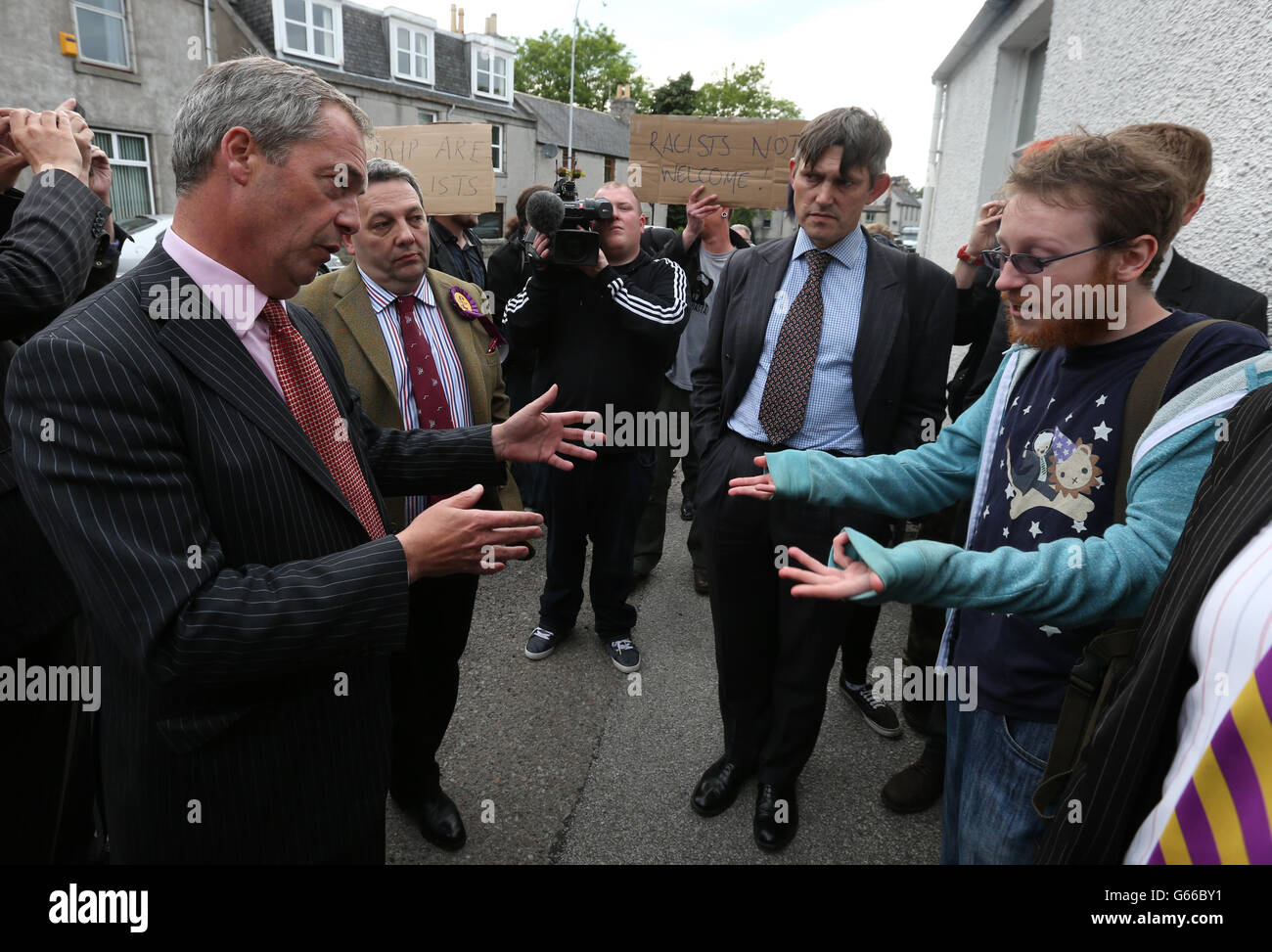 UKIP Leader Nigel Farage speaks with protesters as he campaigns for ...