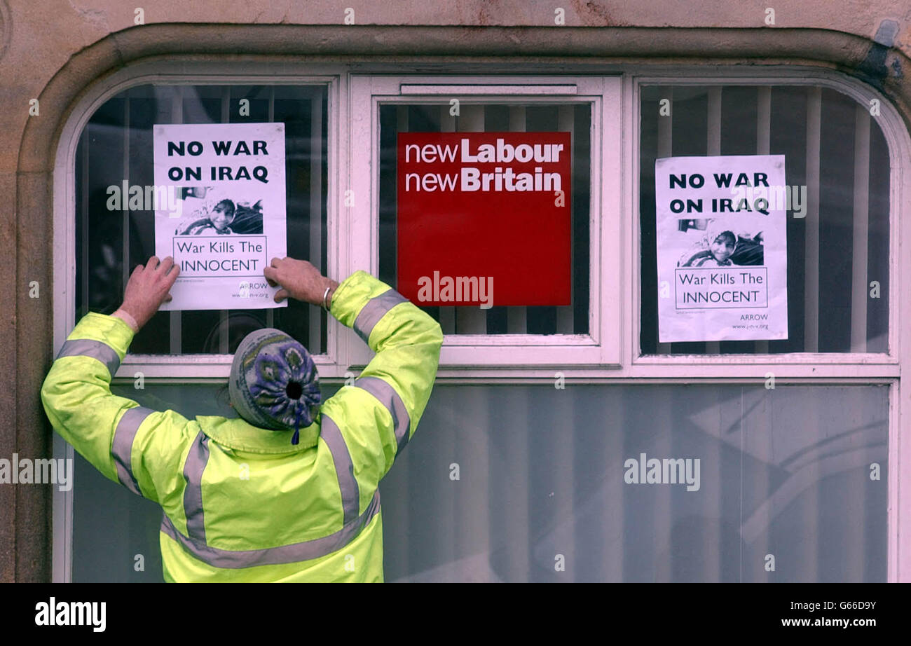 An anti-war protestor places a sign on the Labour Party Headquarters in ...