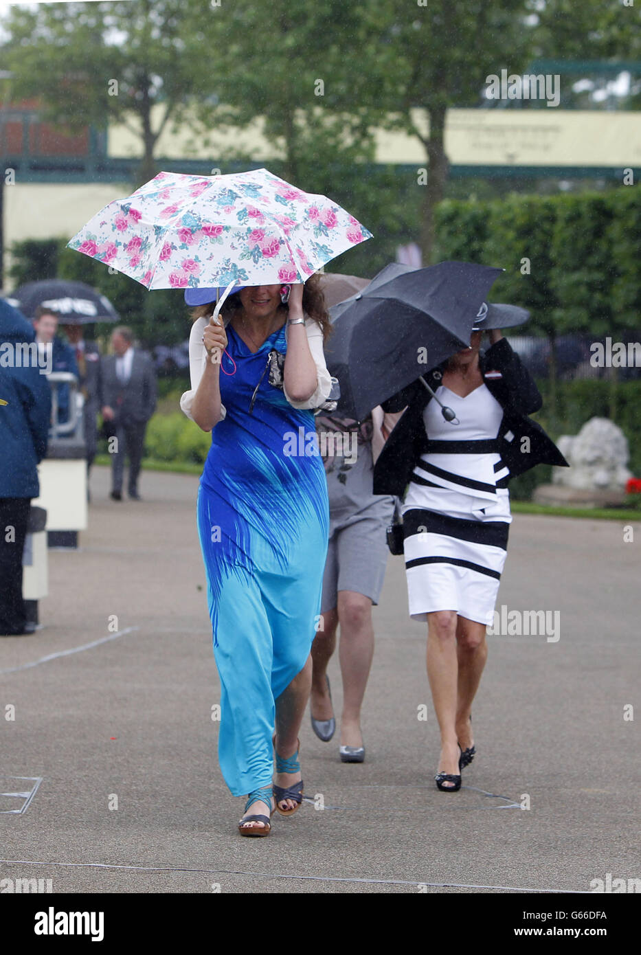 Race goers struggle in the windy conditions during day five of the ...