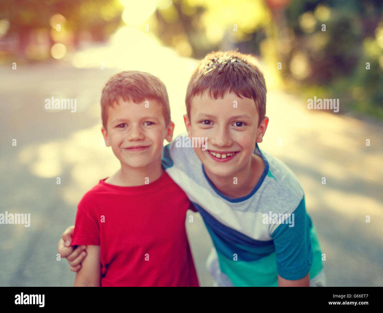 Happy little kids in sunset, vintage portrait Stock Photo - Alamy