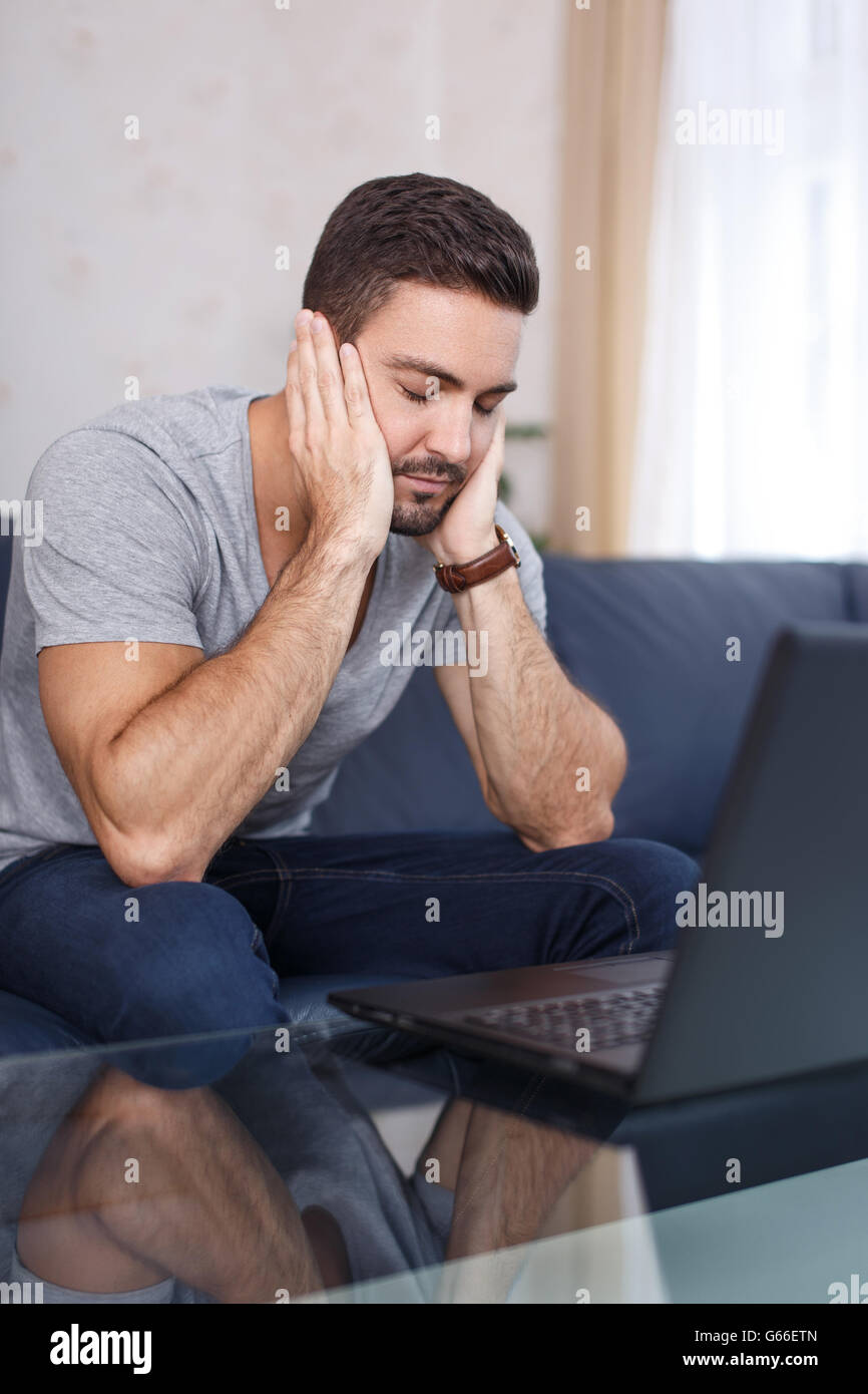 Man sleep in front of laptop at home Stock Photo - Alamy