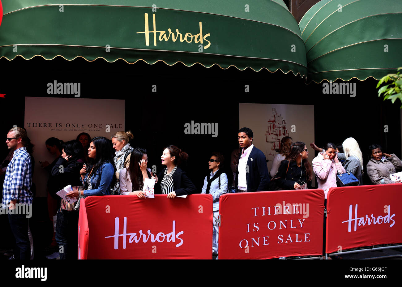 People queue outside Harrods in Knightsbridge, central London, as they ...