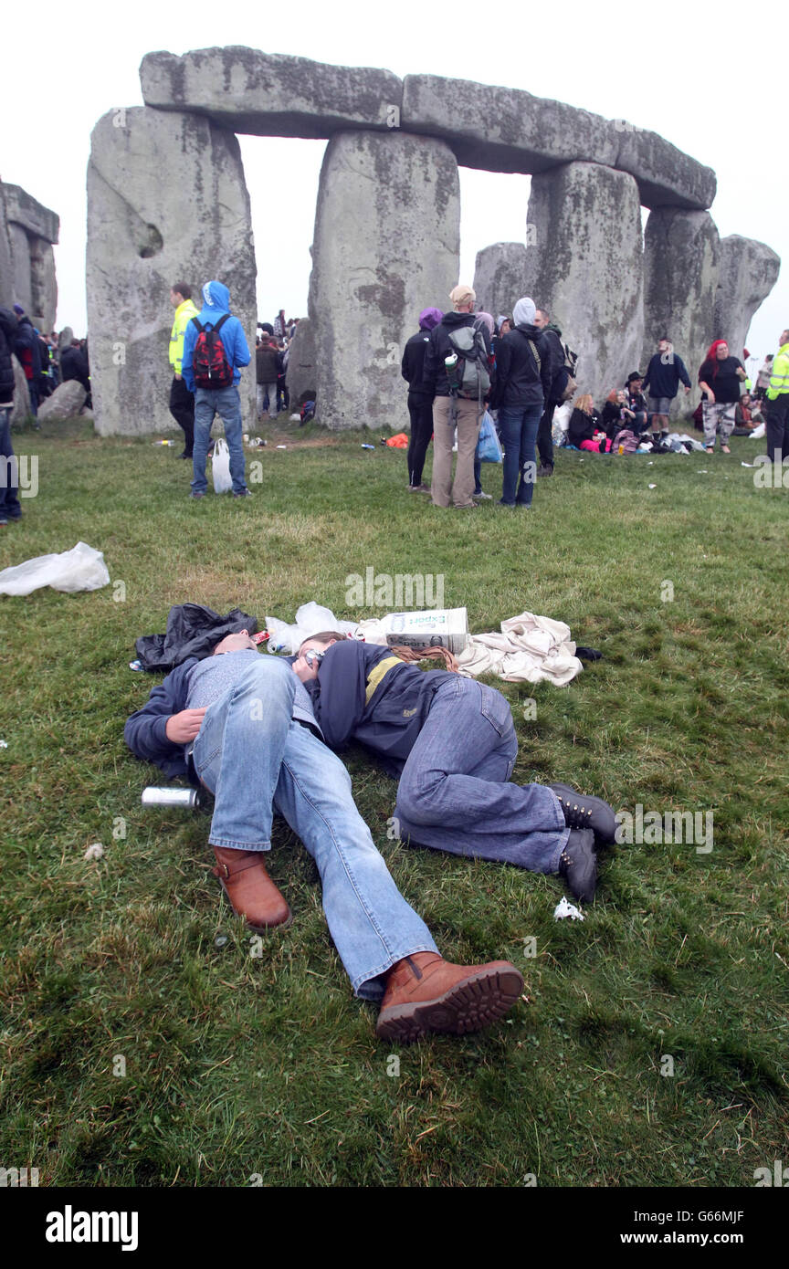 Summer Solstice at Stonehenge. Crowds gather at dawn amongst the stones ...