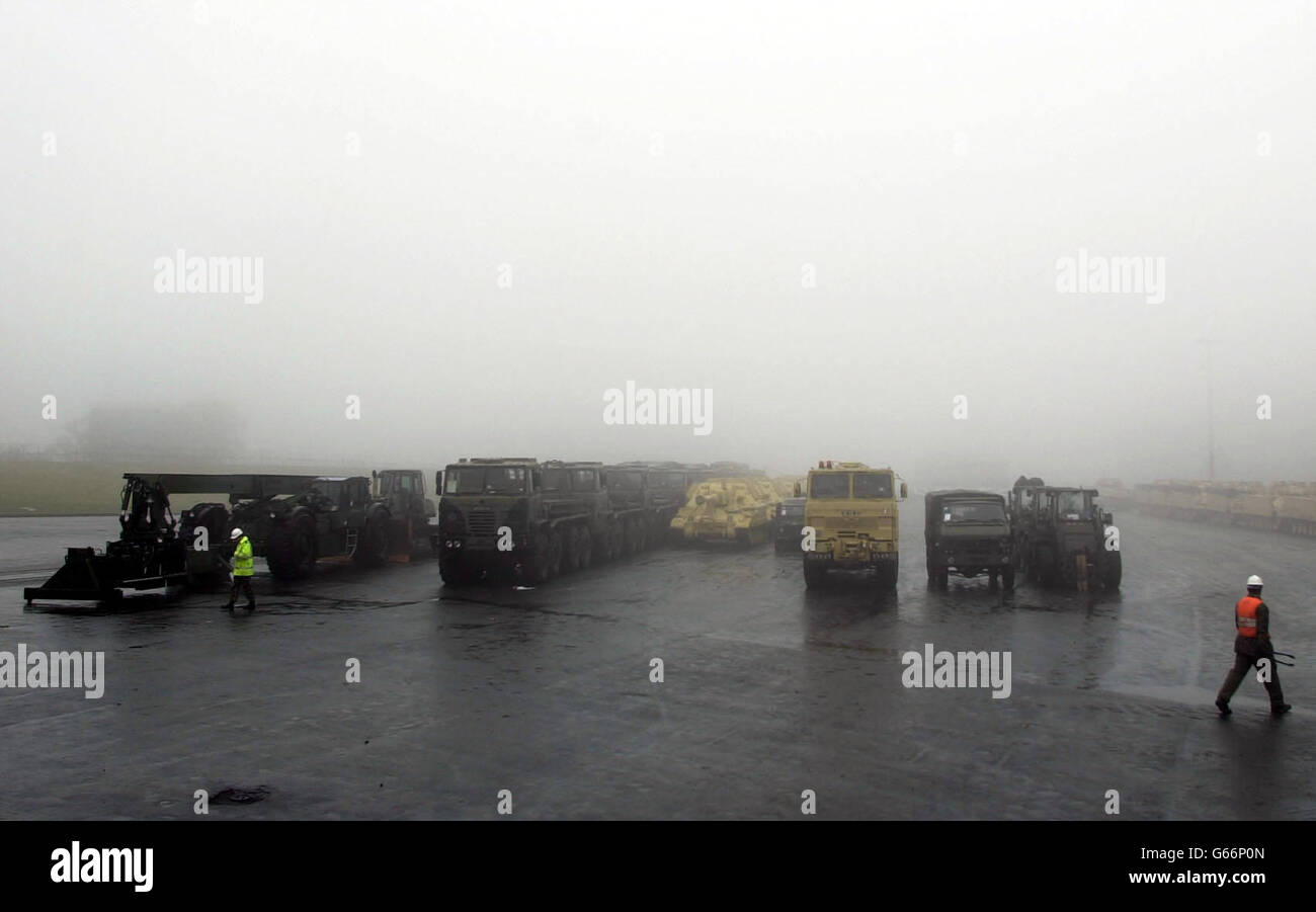 British military vehicles are parked up before being loaded onto the MV ...