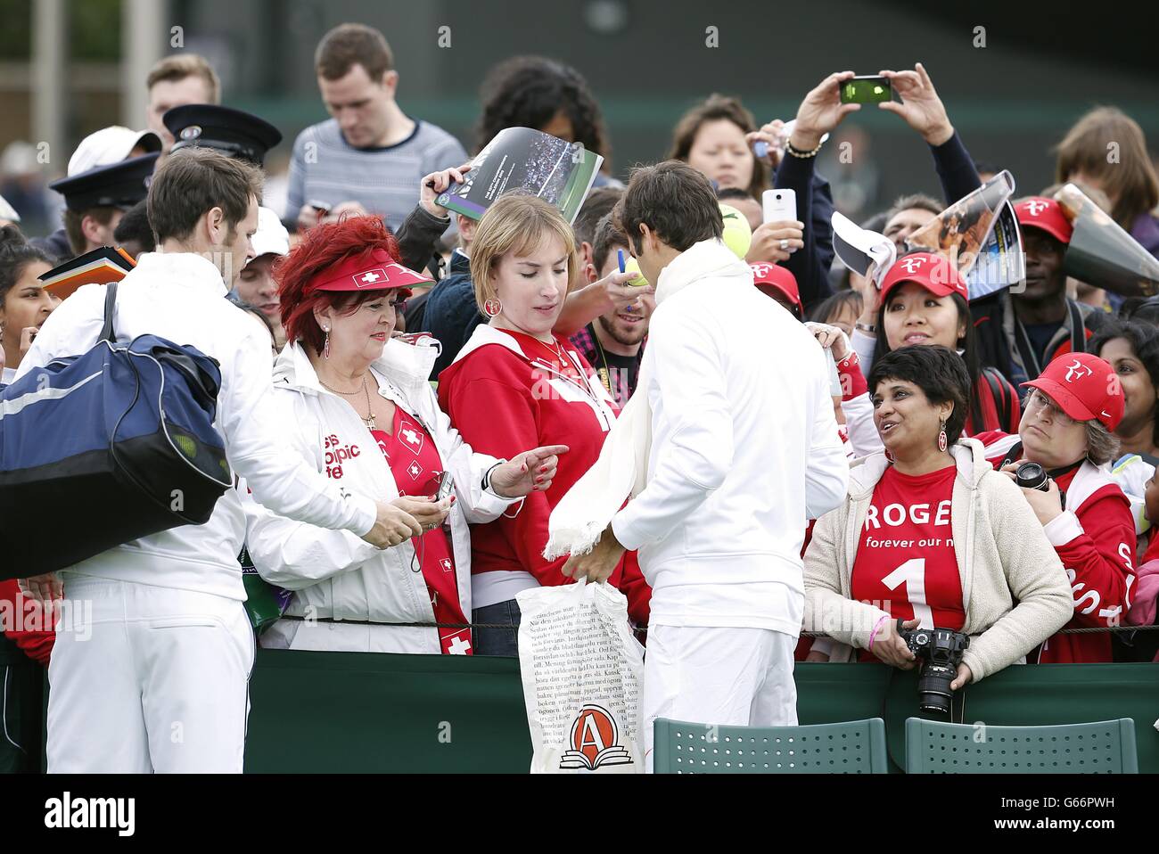 Switzerland's Roger Federer signs autographs for waiting fans during ...