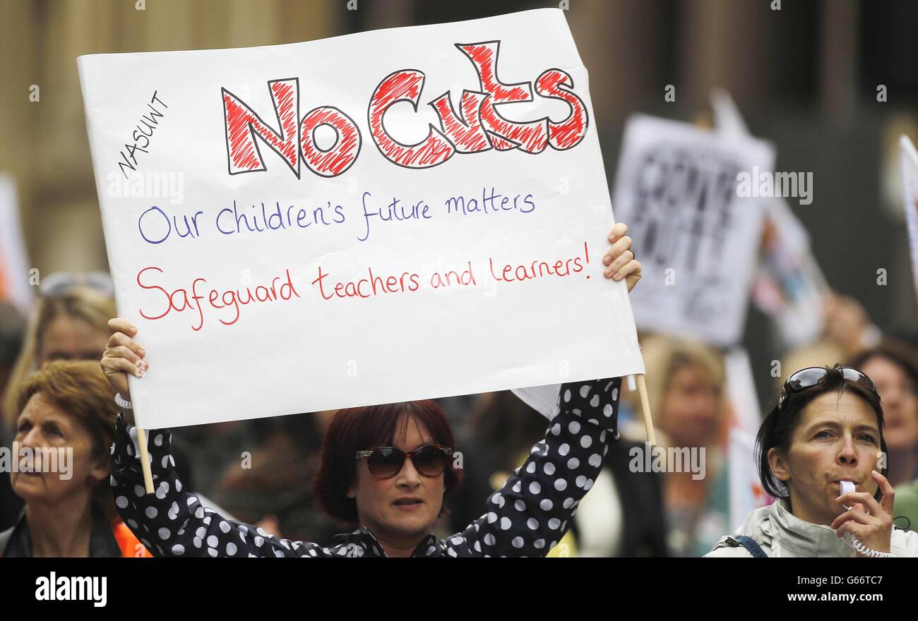 A protesting teacher holds a card during the NASUWT rally of striking ...