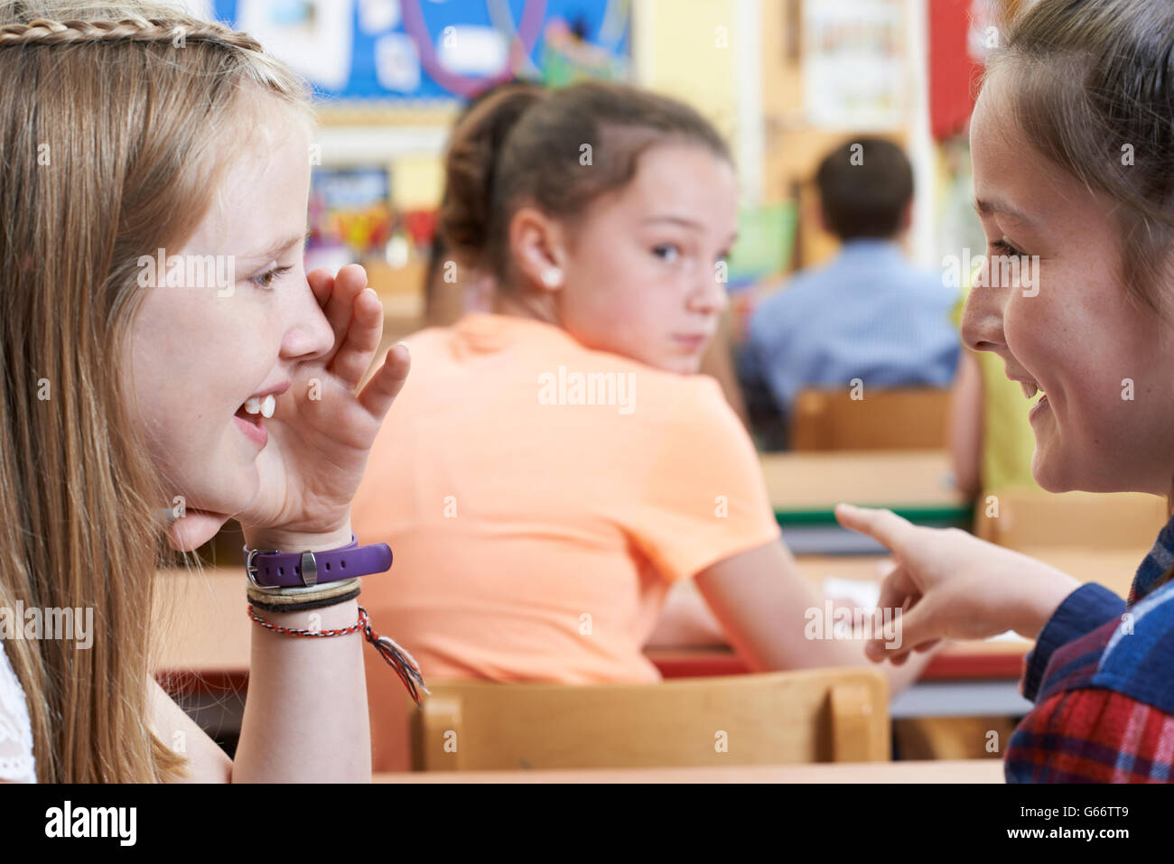 Unhappy Girl Being Gossiped About By School Friends In Classroom Stock ...