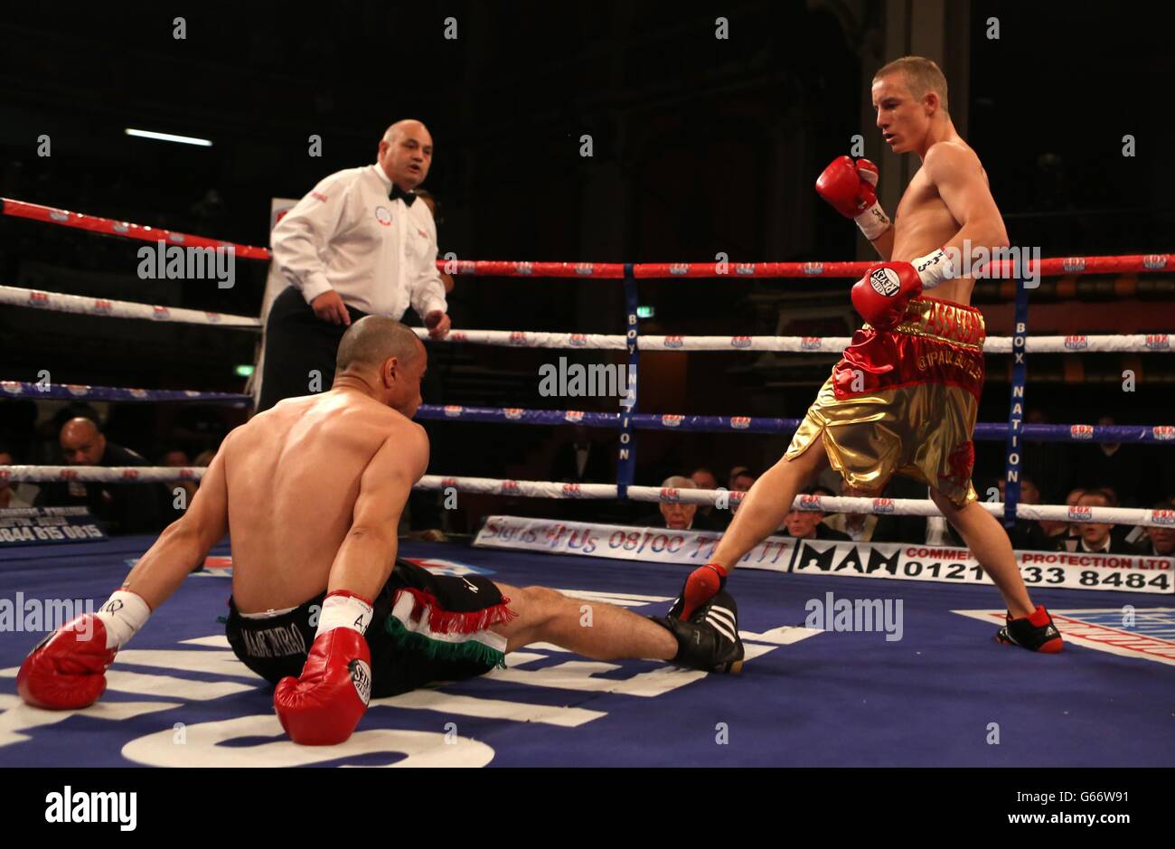 Paul Butler (right) knocks down Ali Najah during their Commonwealth ...