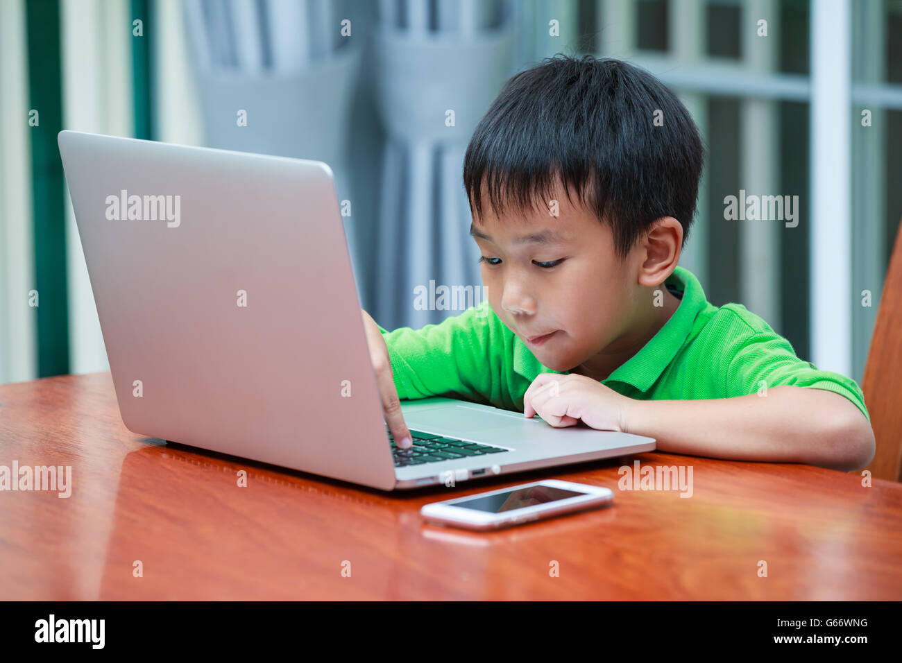 Happy asian child. Handsome boy enjoying modern generation technologies ...