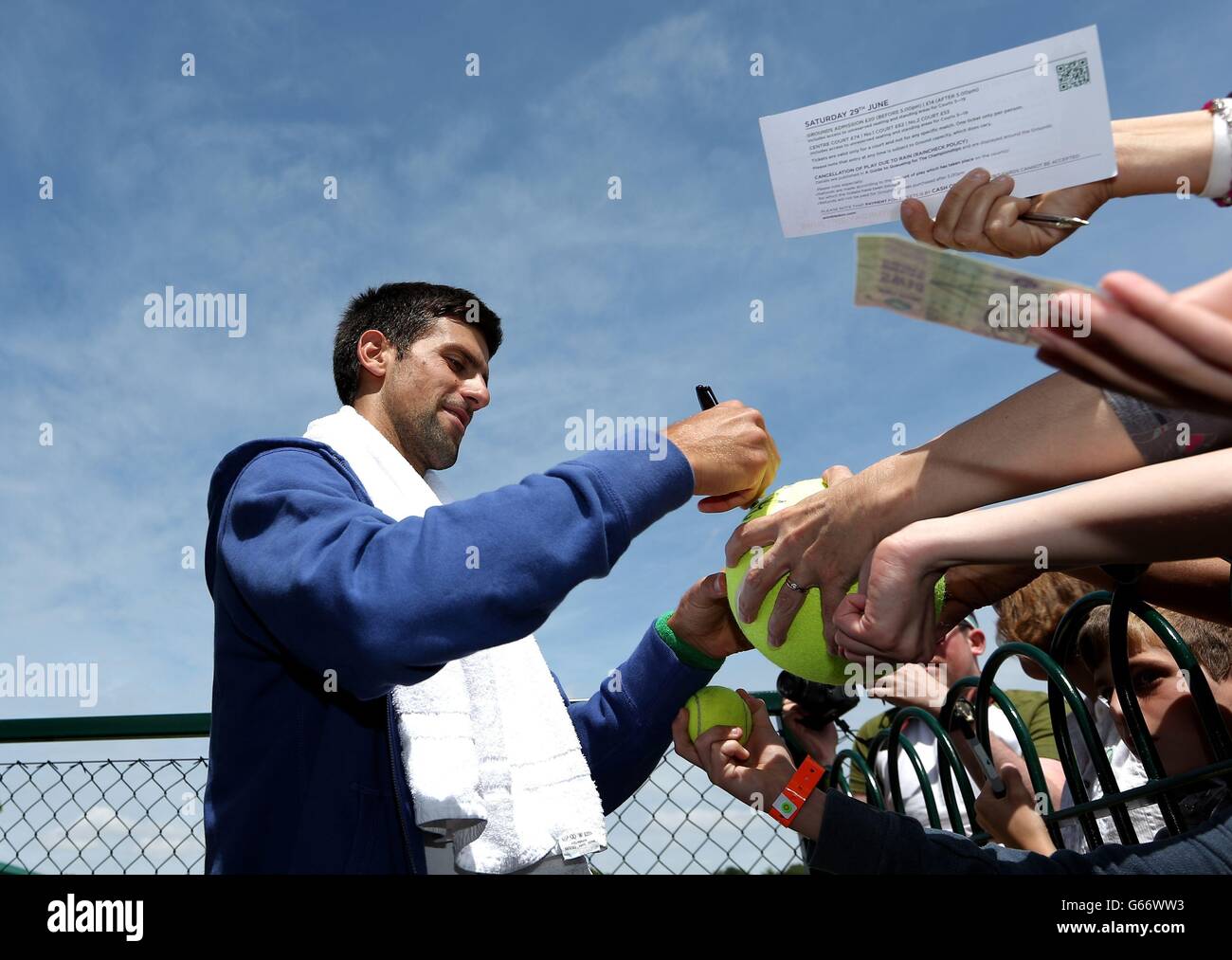 Serbia's Novak Djokovic signs autographs following a practice session ...