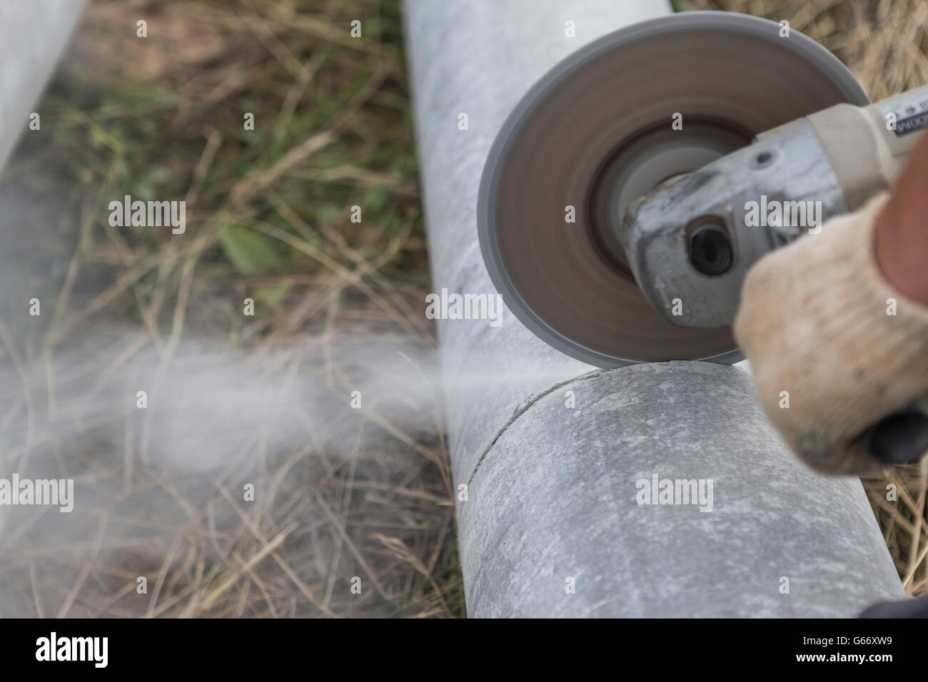 Work sawing asbestos pipe for foundation electric tool Stock Photo - Alamy