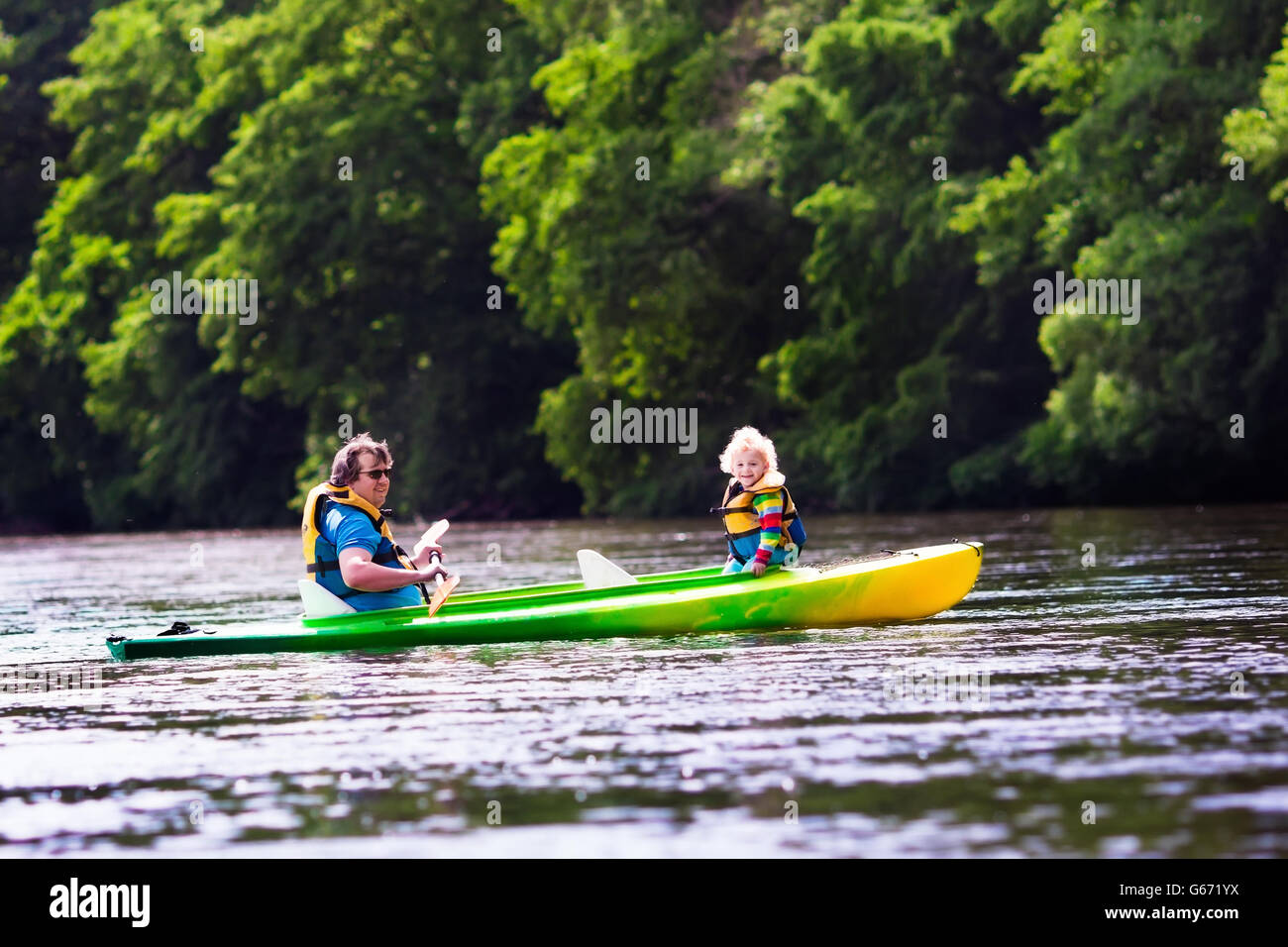 Family on kayaks and canoe tour. Mother and child paddling in kayak in ...