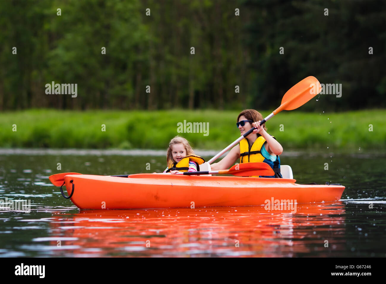 Family on kayaks and canoe tour. Mother and child paddling in kayak in ...