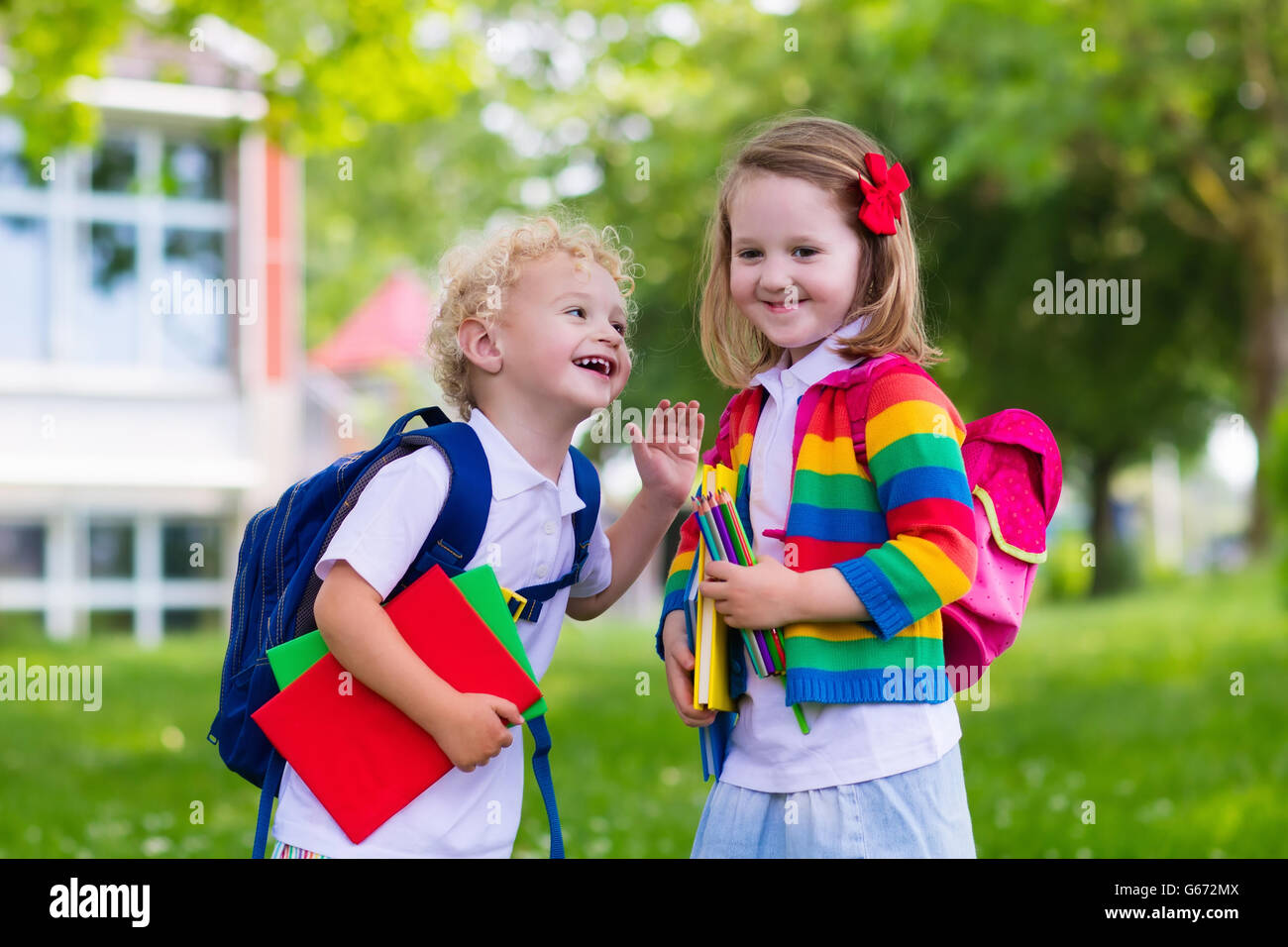 Child going to school. Boy and girl holding books and pencils on first ...
