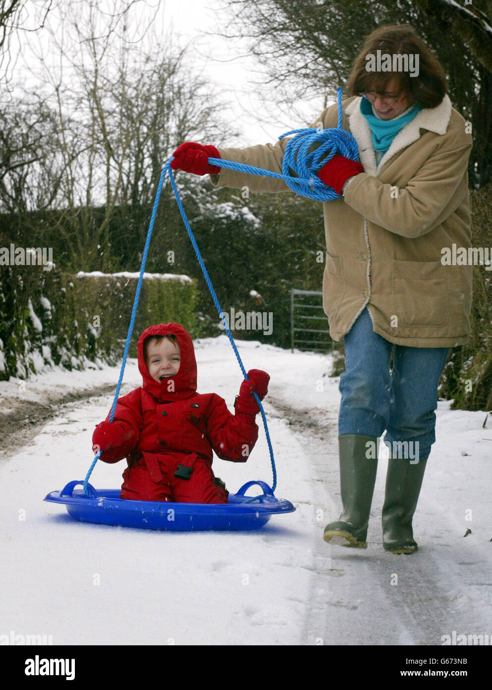 Daniel Faith, aged 4, is pulled in his sledge by his mum Margaret, in ...