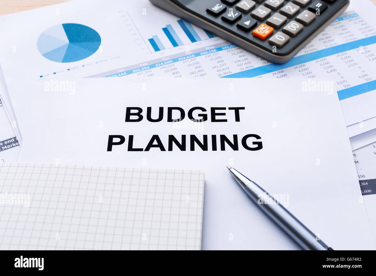 Budget planning with financial data and calculator on desk Stock Photo ...