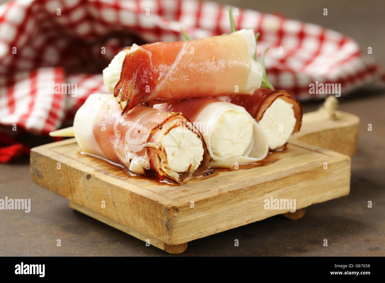 Italian appetizer soft cheese wrapped in parma ham Stock Photo - Alamy