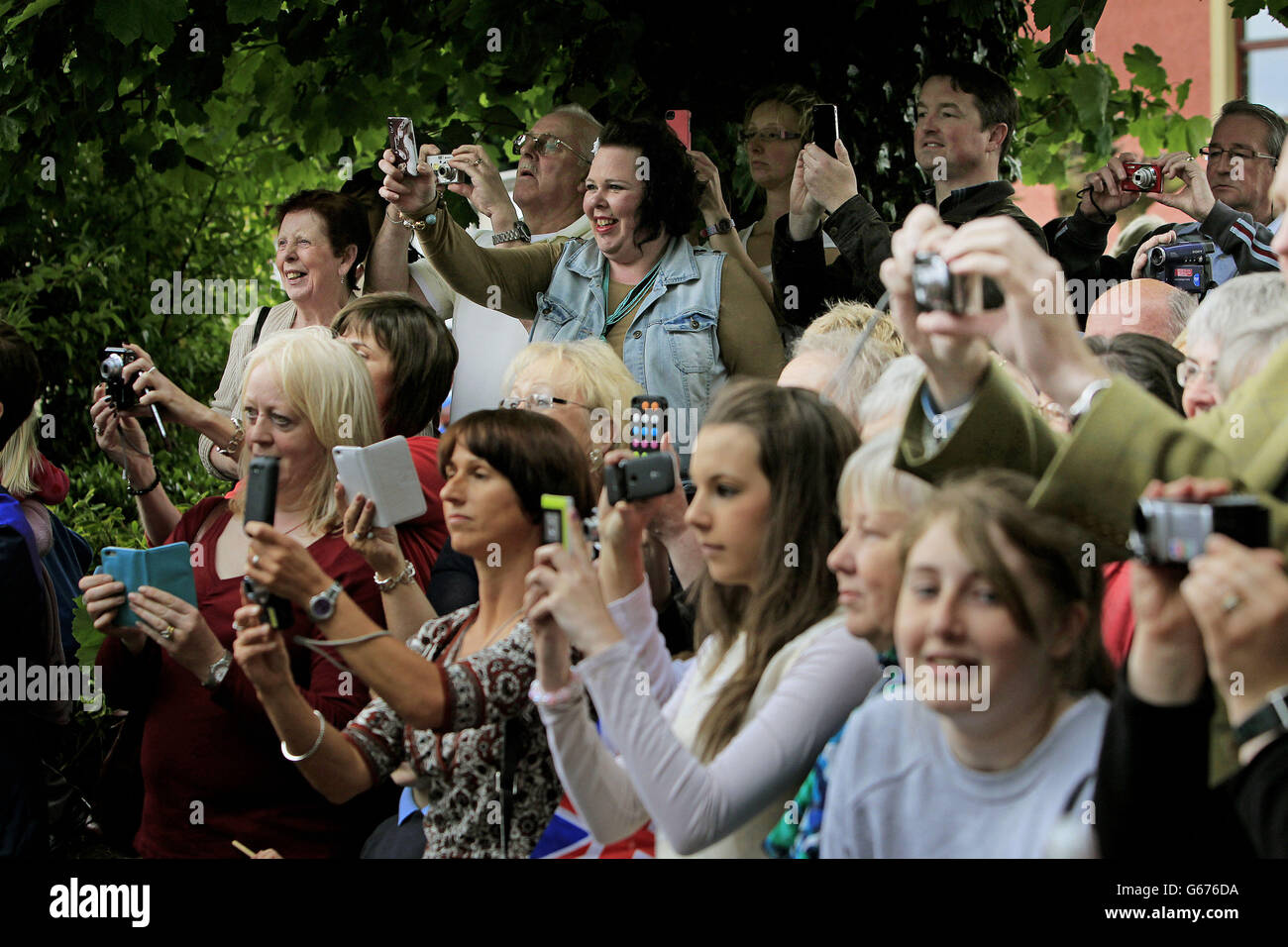 People take a pictures of the Prince of Wales and the Duchess of ...