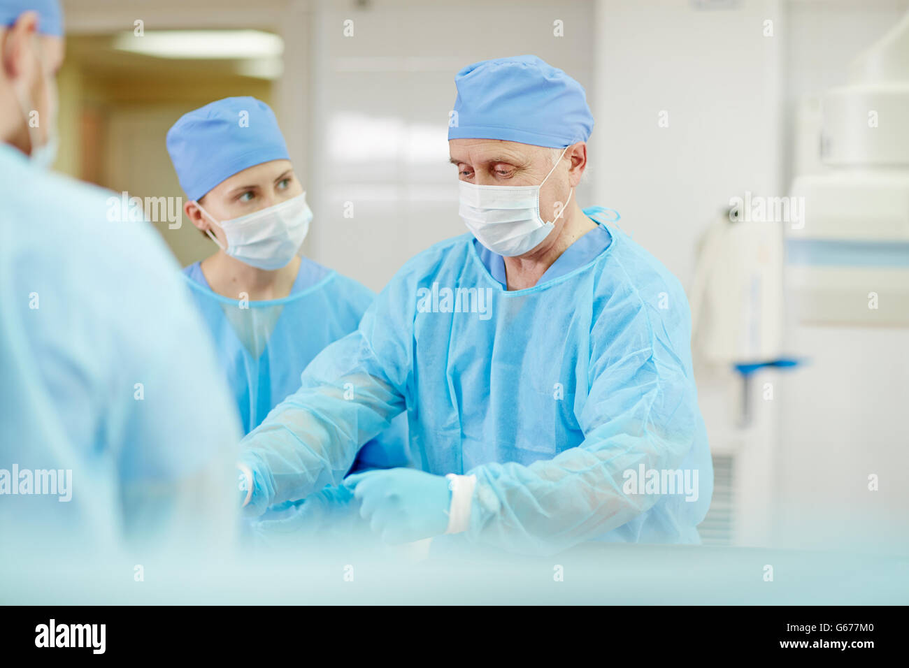 Senior specialist performing operation Stock Photo - Alamy