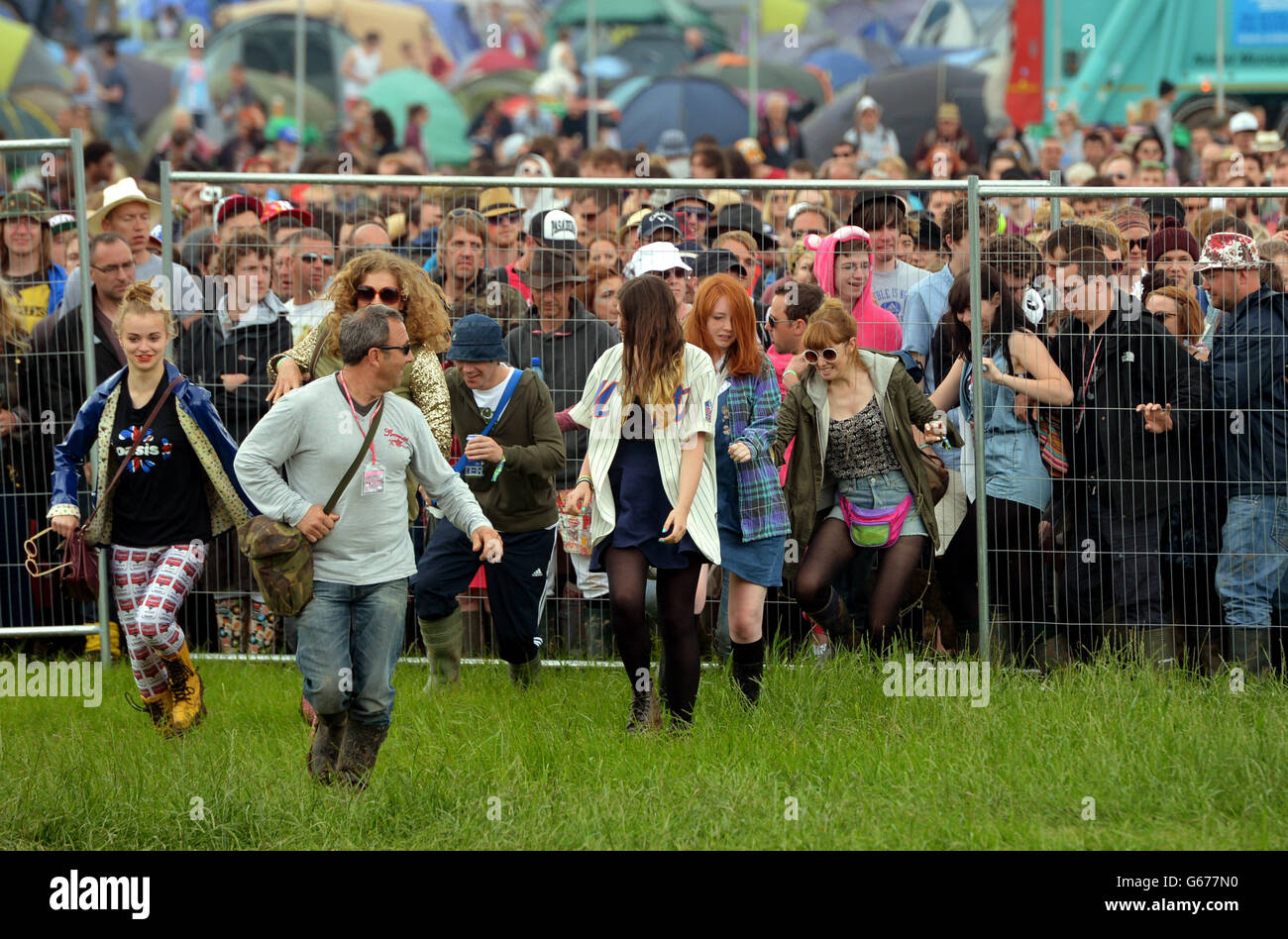 The crowd break through the fence to the Other Stage ahead of Beady Eye ...