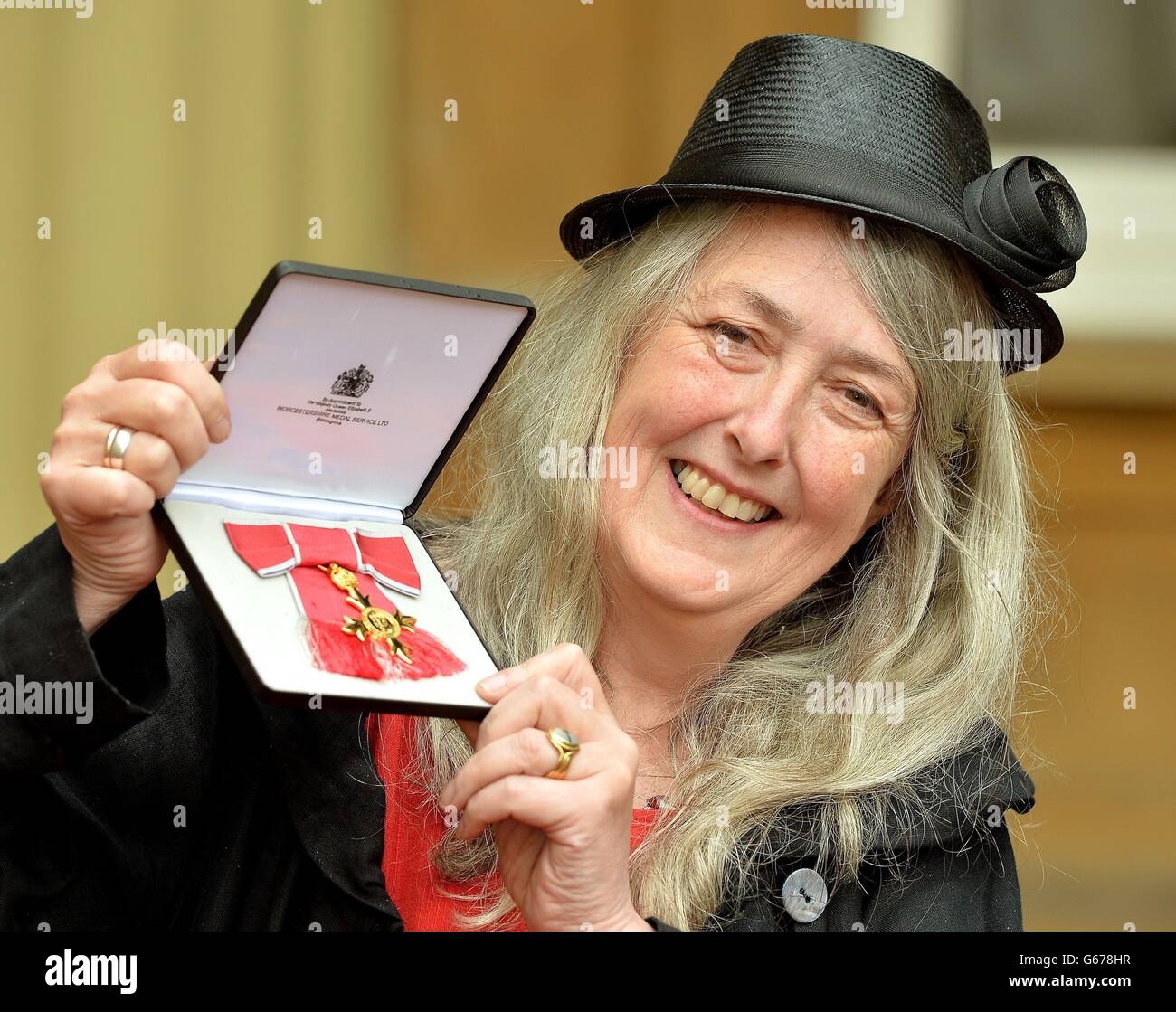 Professor Mary Beard holds her OBE medal, after she received the award ...
