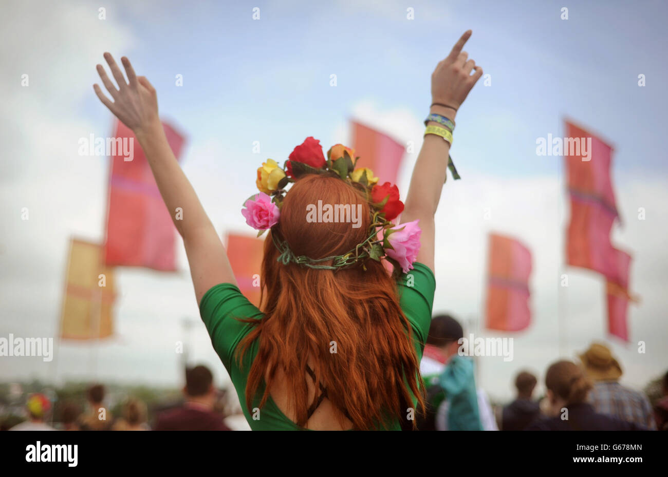 A woman wears a floral hair band during the first performance day of ...