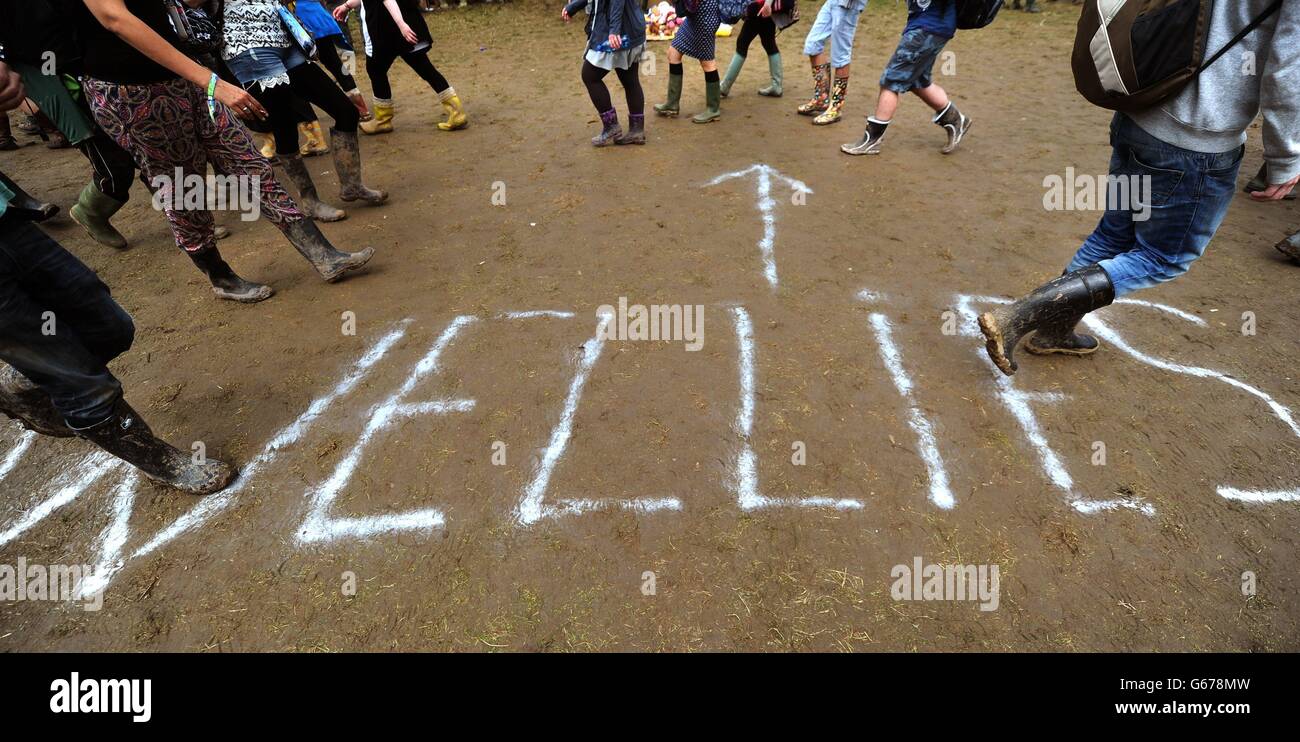 A sign advertising wellies for sale is painted on the ground during the ...