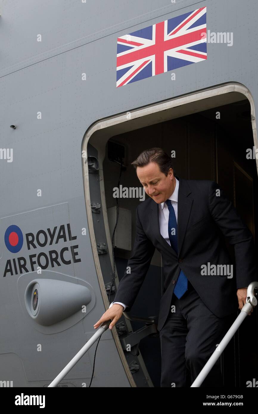 British Prime Minister David Cameron steps out of a C17 Globemaster ...