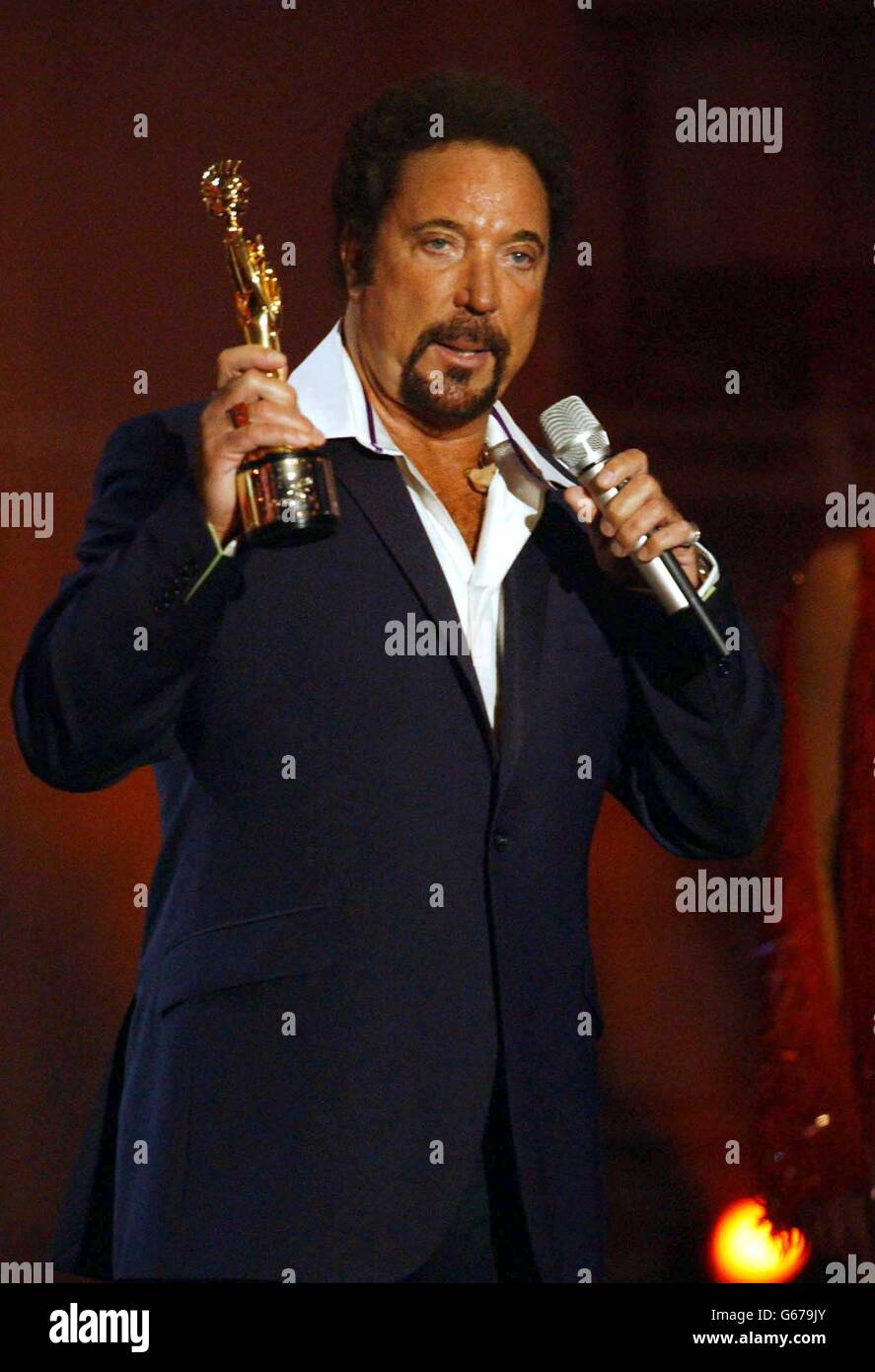 Singer Tom Jones holds the Outstanding Contribution Award during The ...