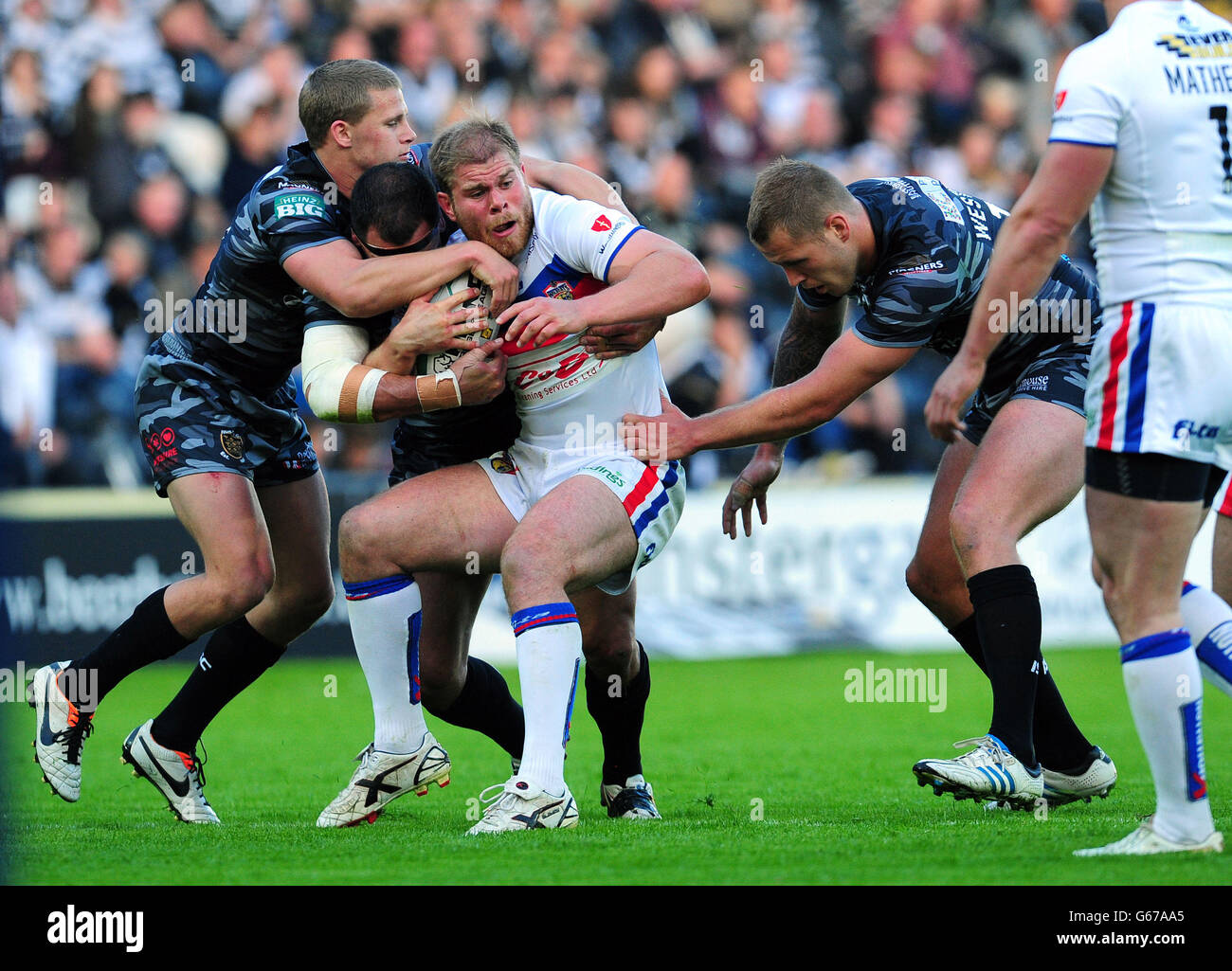 Wakefield Wildcats' Danny Washbrook is held by the Hull FC defence ...