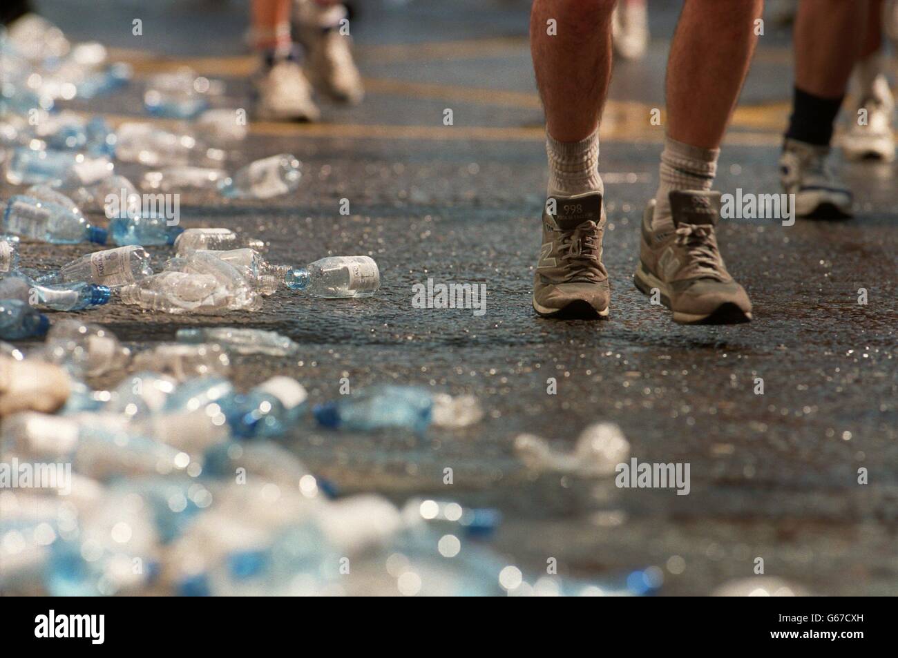 Runner passing water station bottles hi-res stock photography and ...