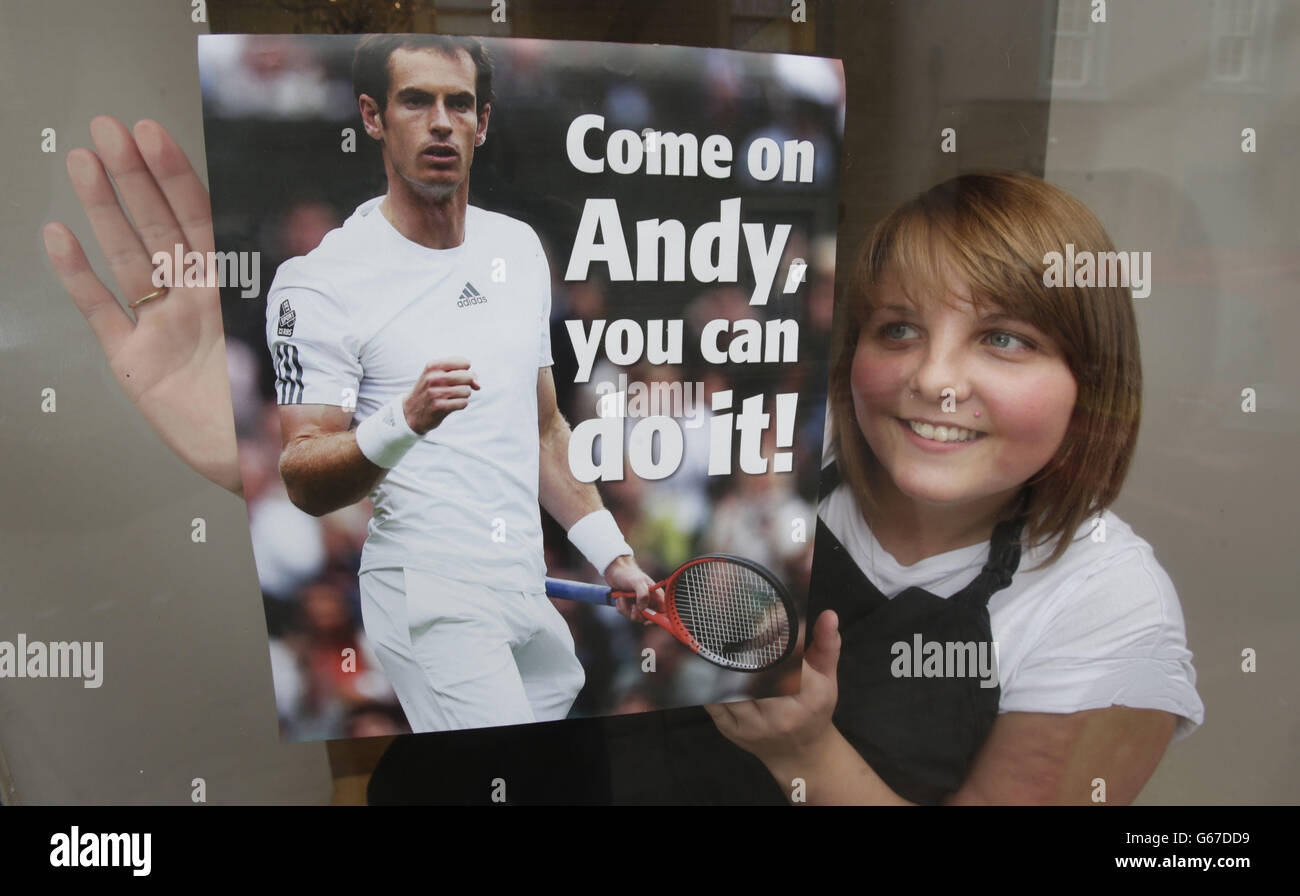 Tracie Cunningham puts a poster in the window of Steven Croal ...