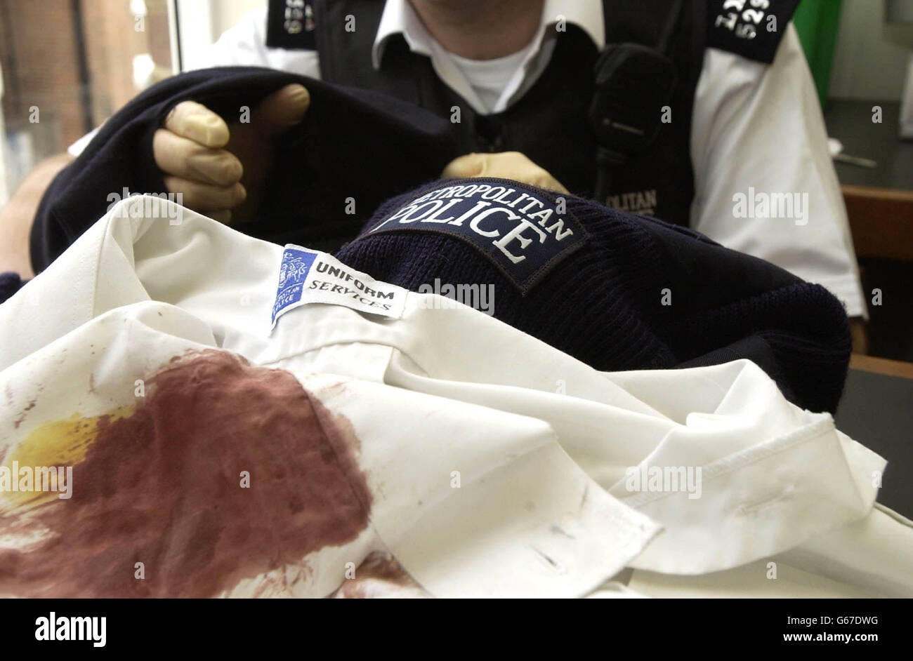 A Police Officer displays the torn and bloody uniforms of colleagues ...