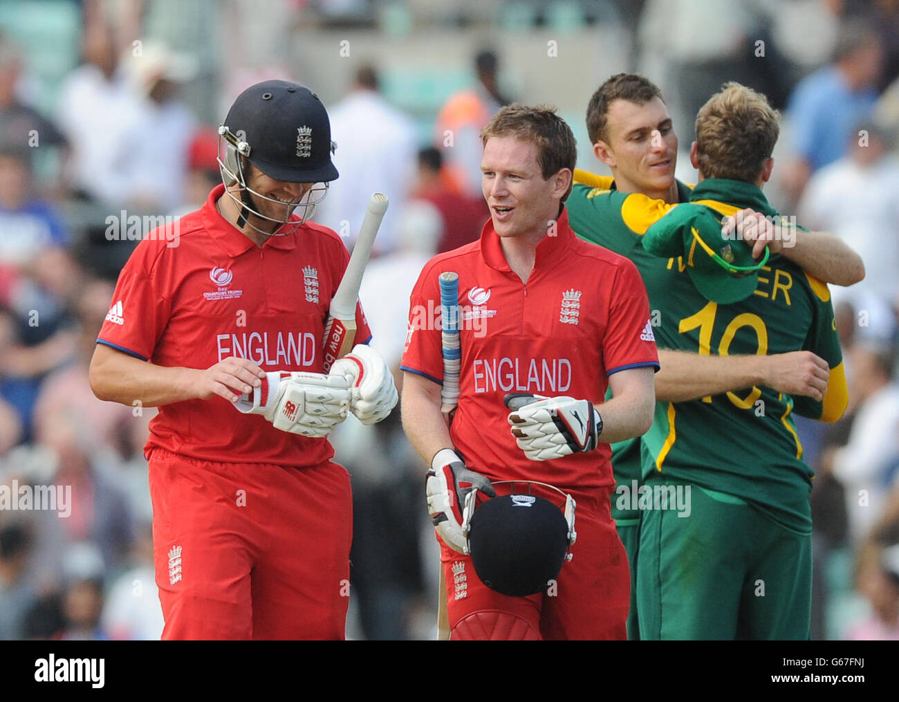 England's Jonathan Trott (left) and Eoin Morgan (centre) celebrate ...