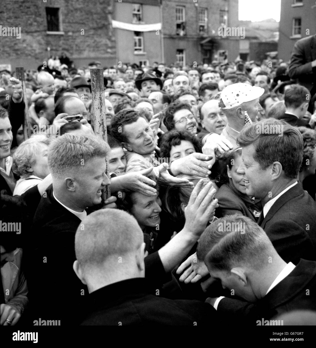 Eager hands stretch put to greet American President John F Kennedy ...