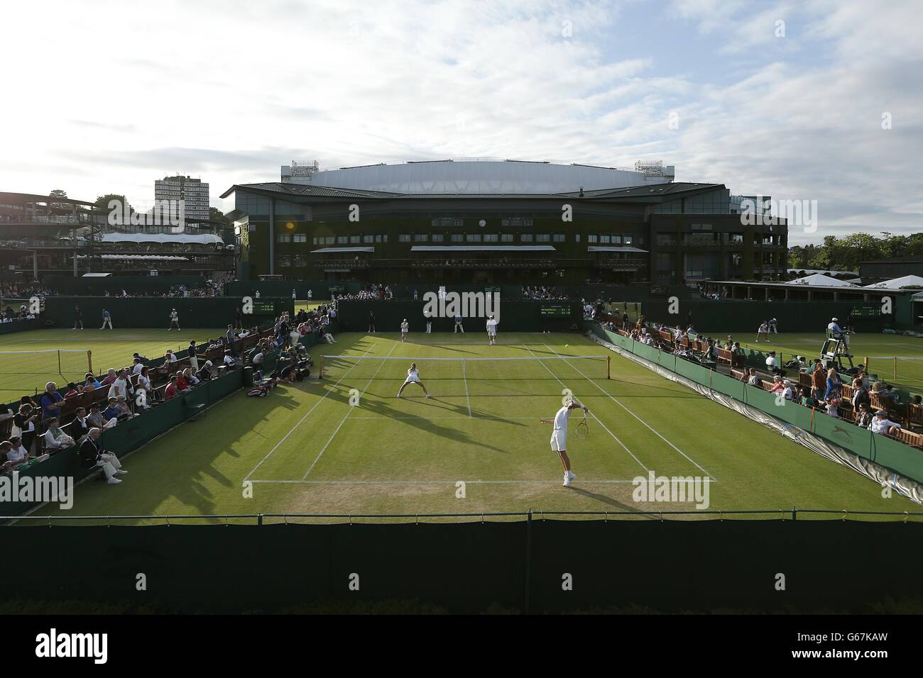 A general view of play on the outside courts, in the late afternoon sun ...