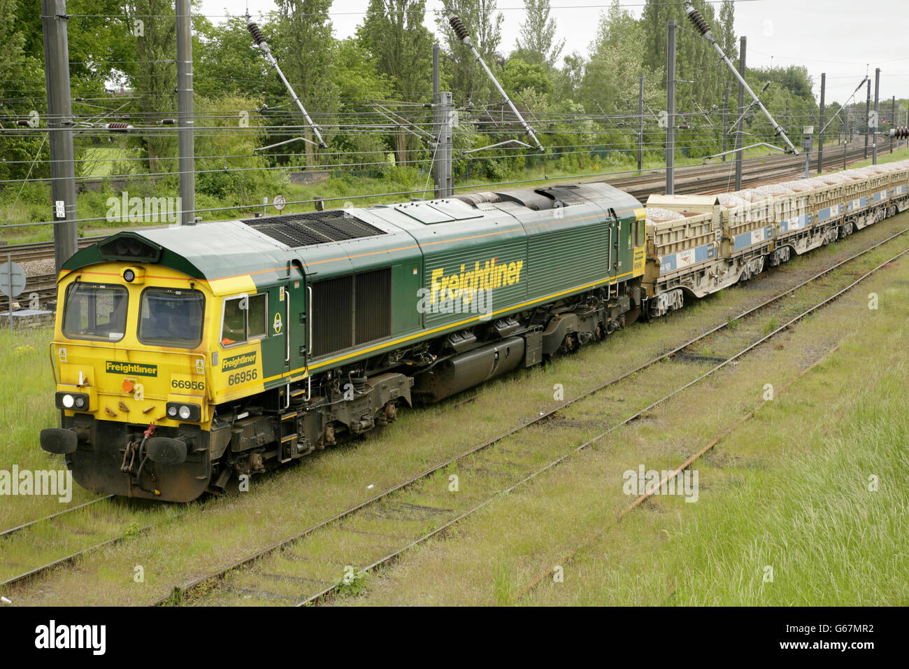 Class 66 diesel locomotive 66956 with train of loaded ballast wagons at ...