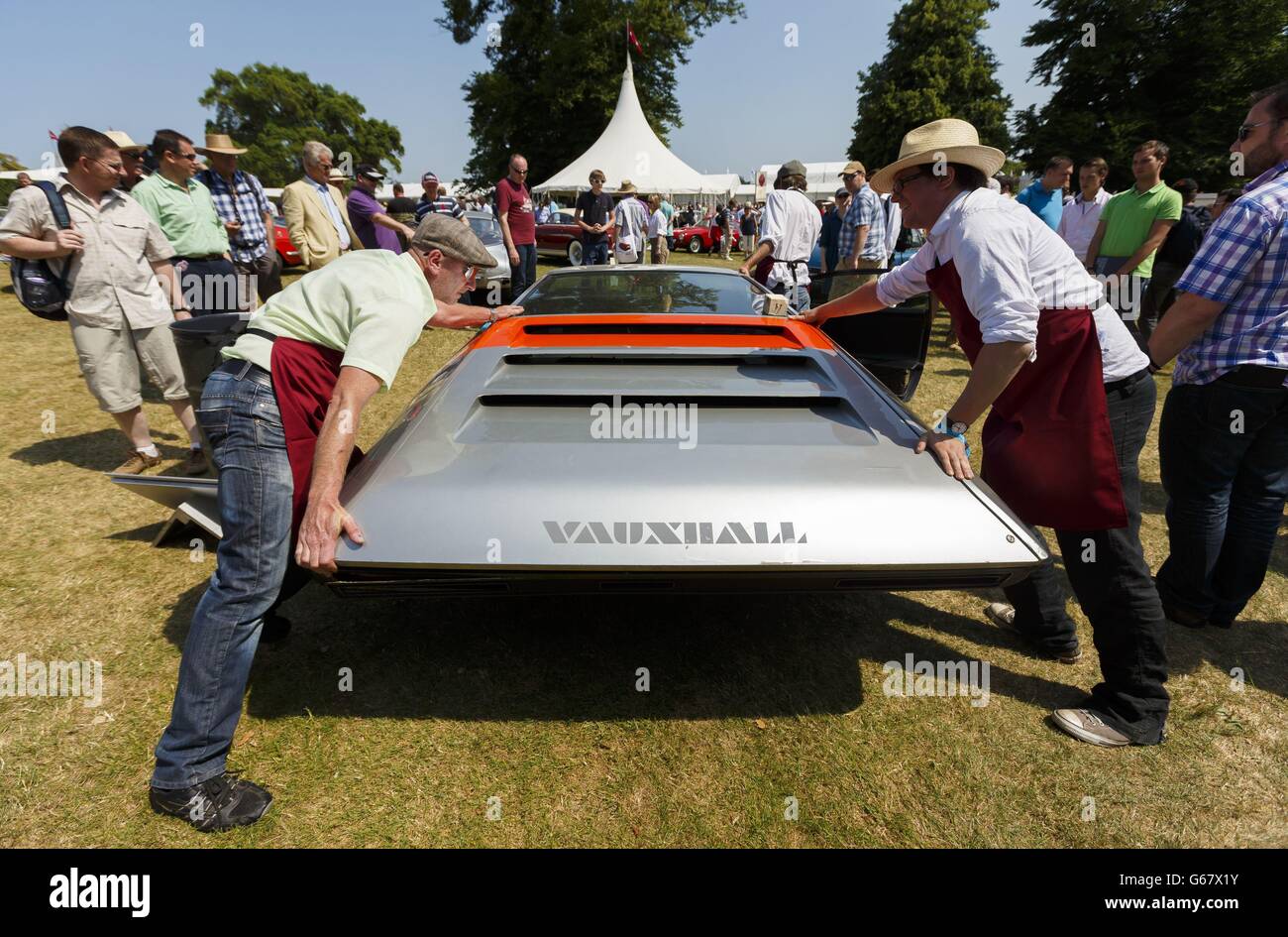 A Vauxhall is pushed into position for display during the Moving Motor ...