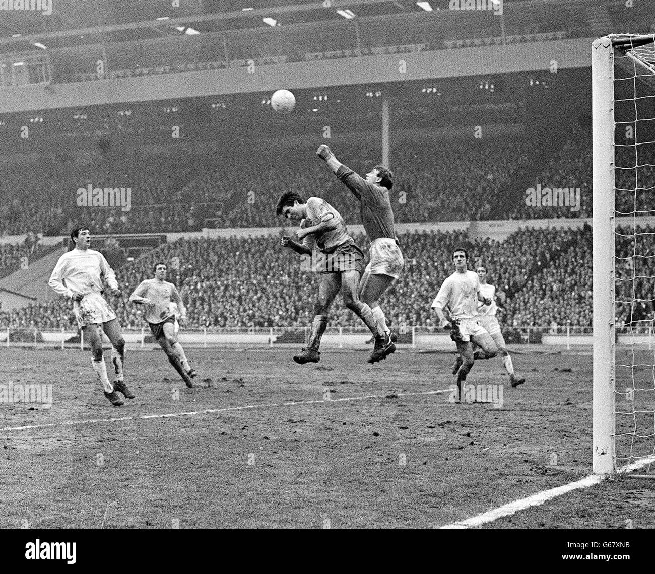 A flying fist from Swindon Town goalkeeper Downsborough saves the ball ...
