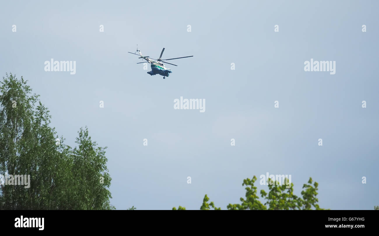 helicopter flies over the forest Stock Photo - Alamy