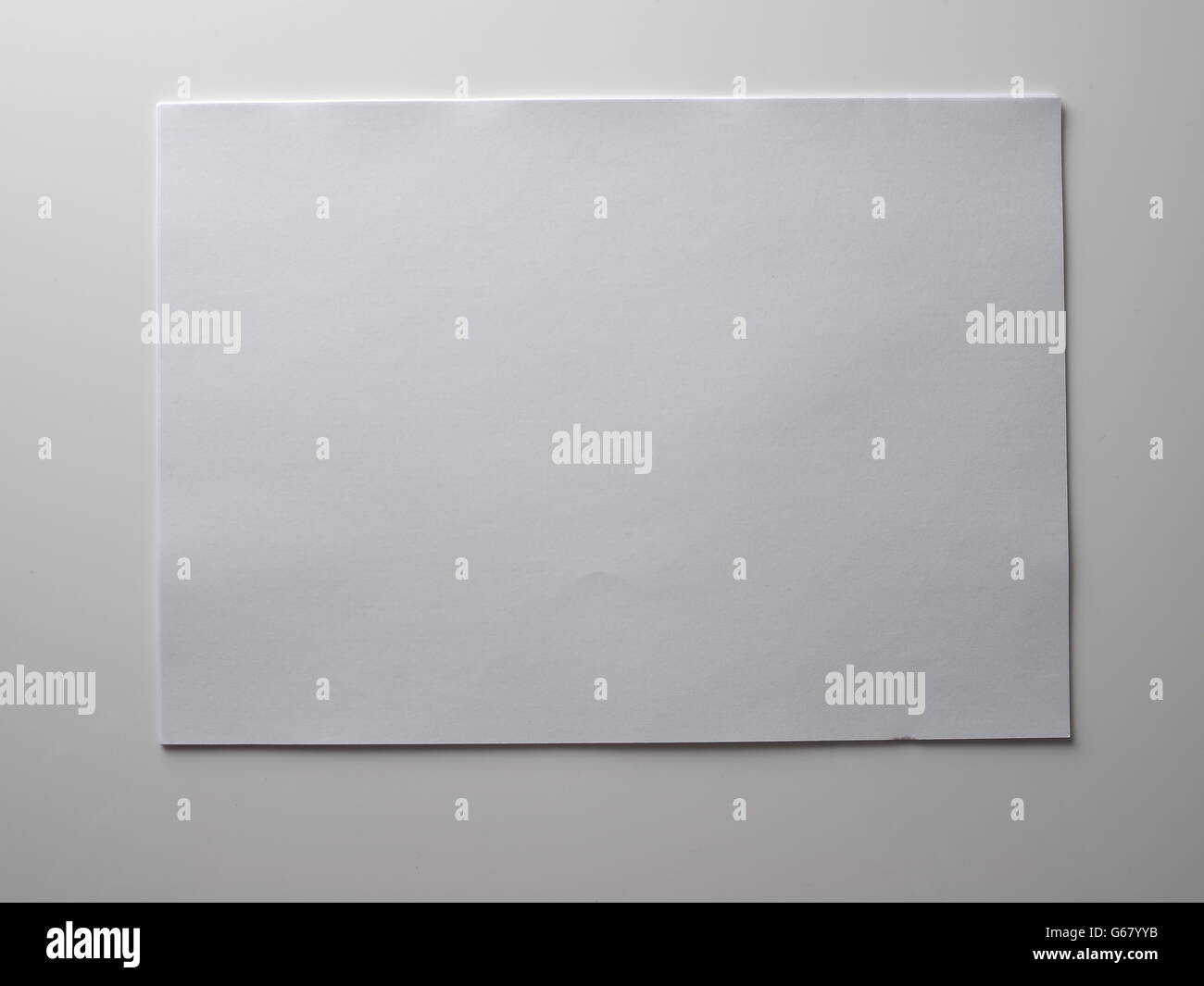 paper a4 on a grey background Stock Photo - Alamy