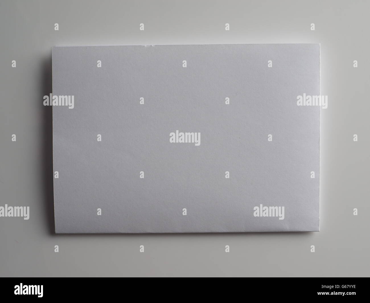paper a4 on a grey background Stock Photo - Alamy