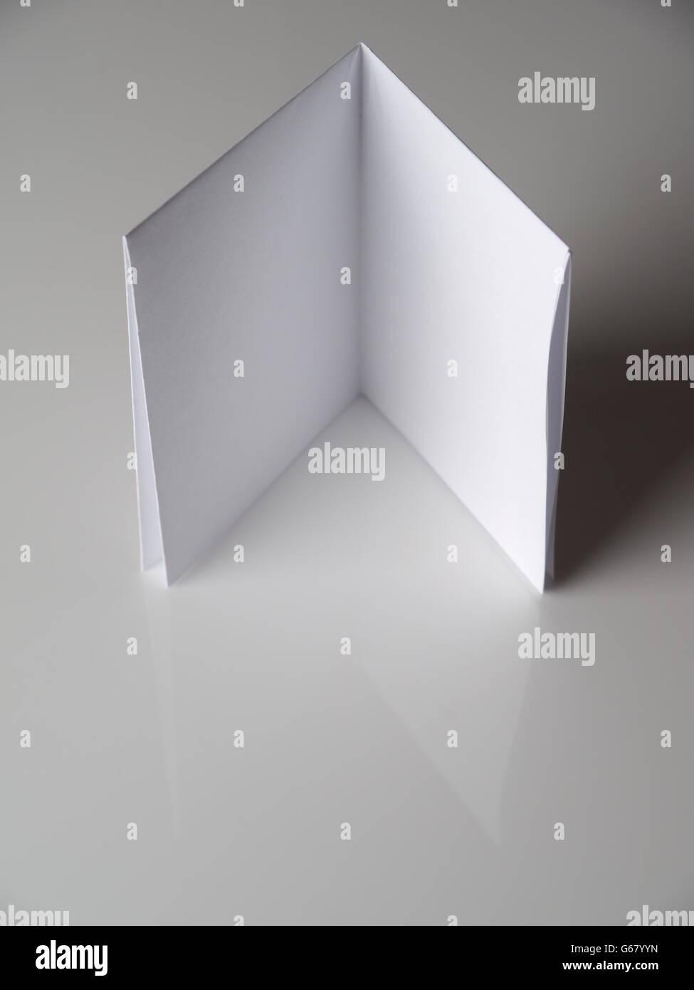 folded paper on a gray background Stock Photo - Alamy