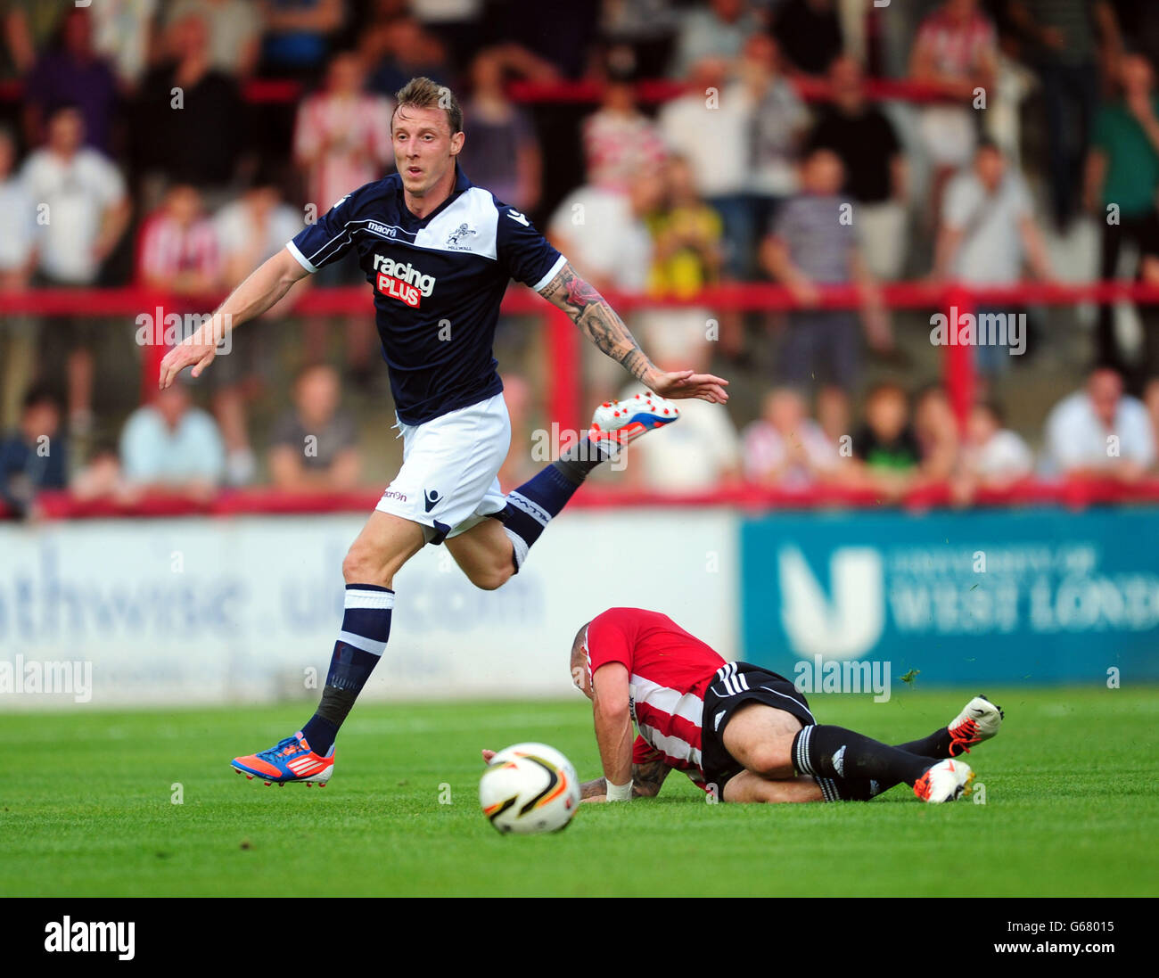 Millwall's Martyn Woolford (left) and Brentford's Alan McCormack battle ...