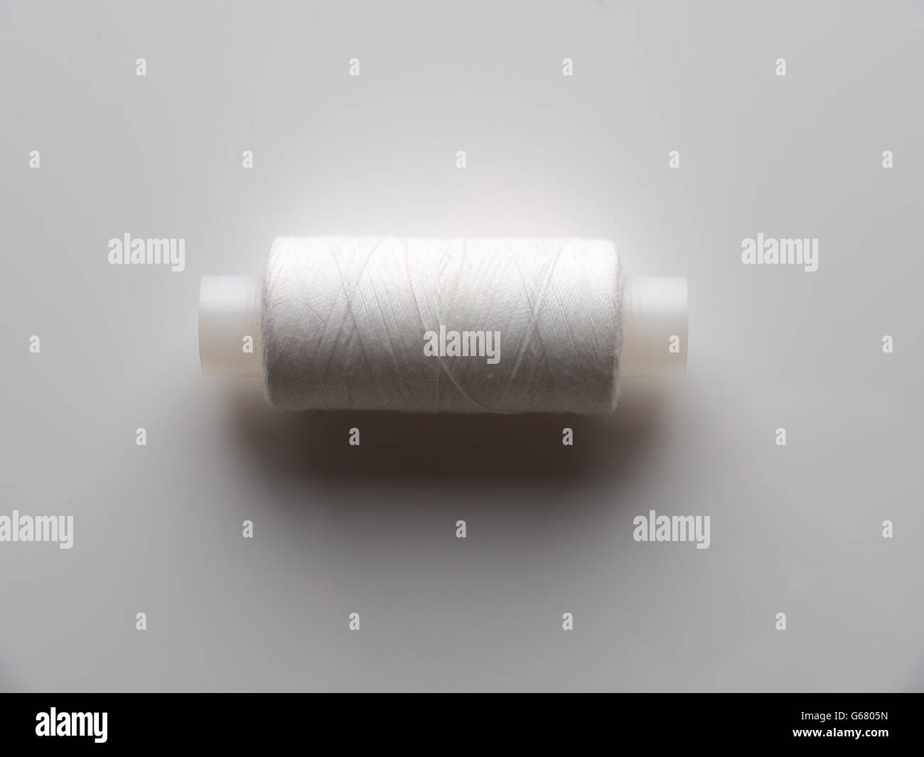 white thread on a gray background Stock Photo - Alamy