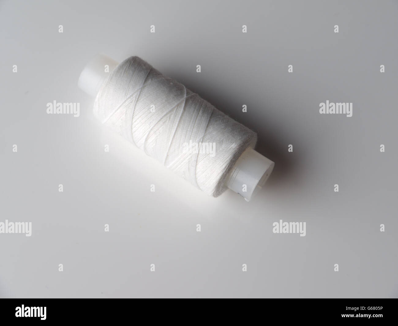 white thread on a gray background Stock Photo - Alamy