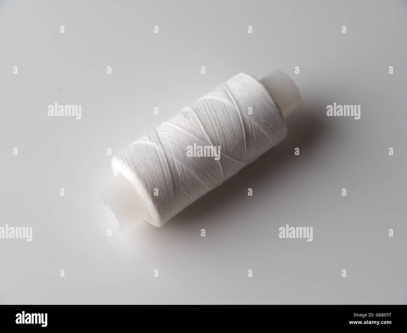 white thread on a gray background Stock Photo - Alamy