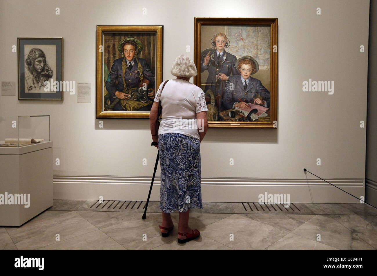 A visitor looks at 'Corporal J.M. Robins' (left) and 'Corporal Elspeth ...