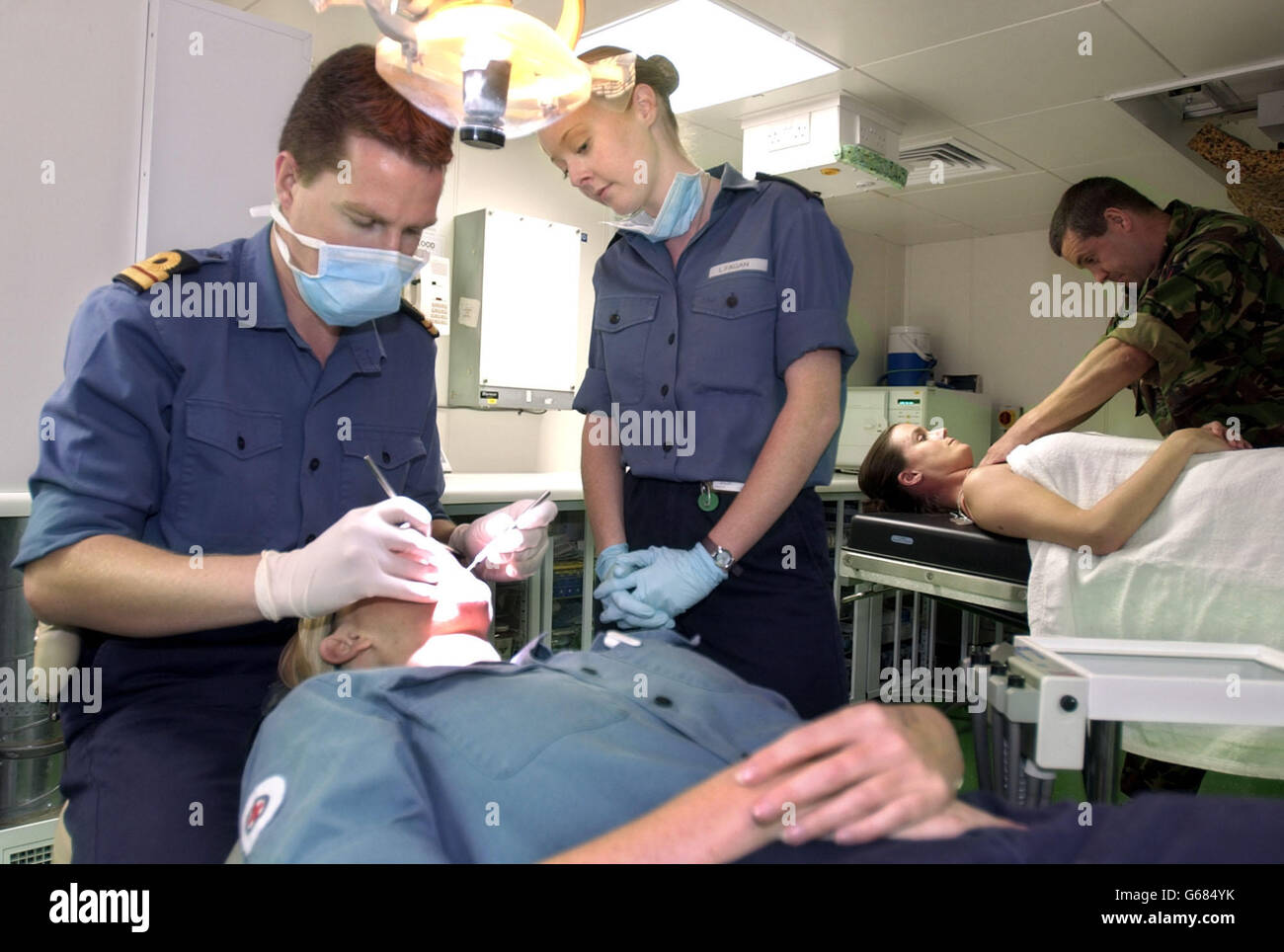 British Navy physiotherapist Major Andy Neaves (right) works on a ...