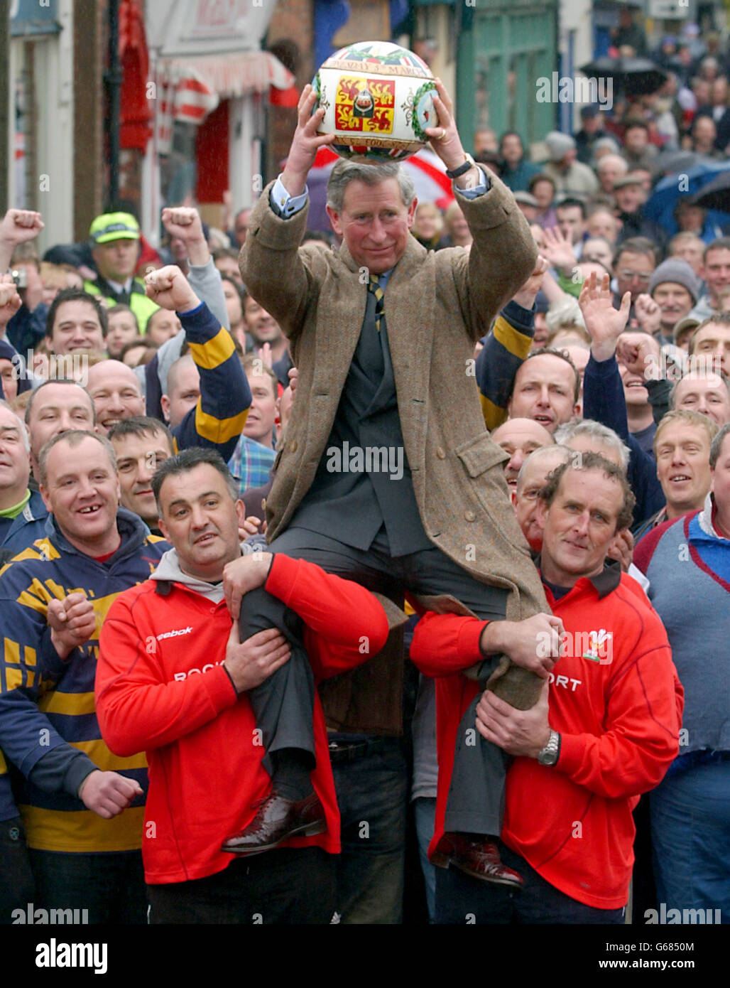 Prince Charles being lifted up holding the ceremonial ball before ...
